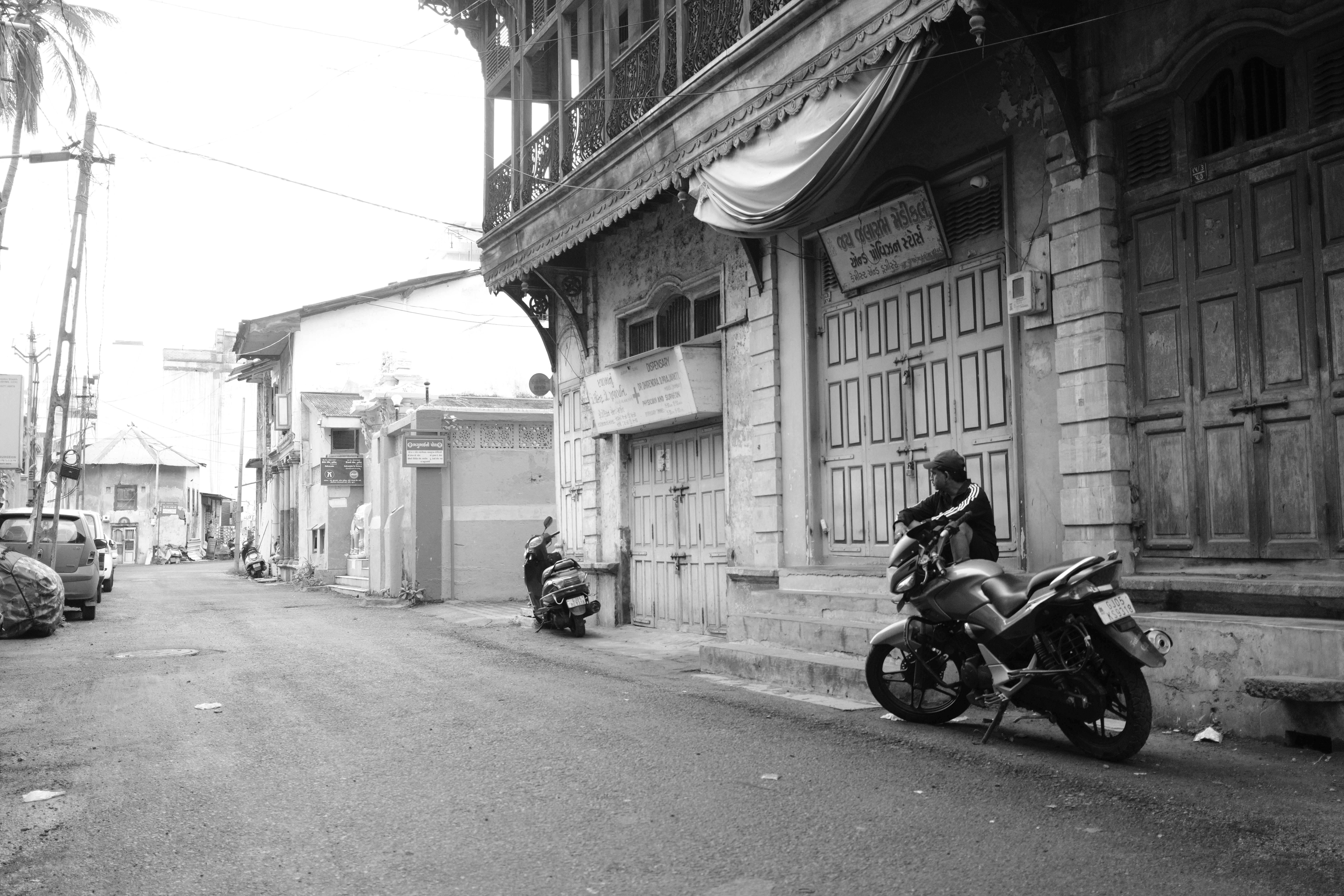 Harboring Silence: A Street Corner with a Waiting Motorcycle