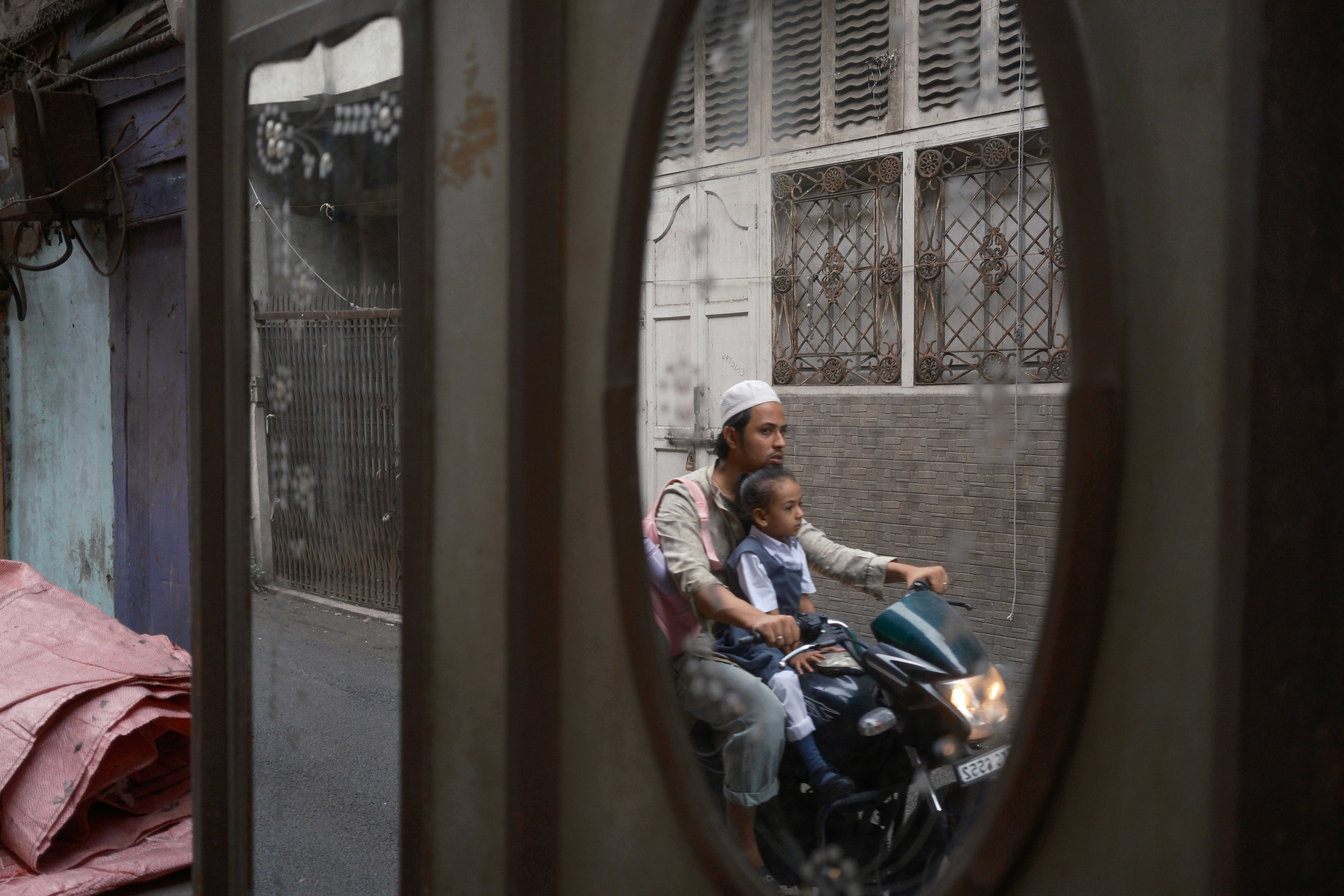 Riding Through the Frame: A Father and Child on a Quiet Street