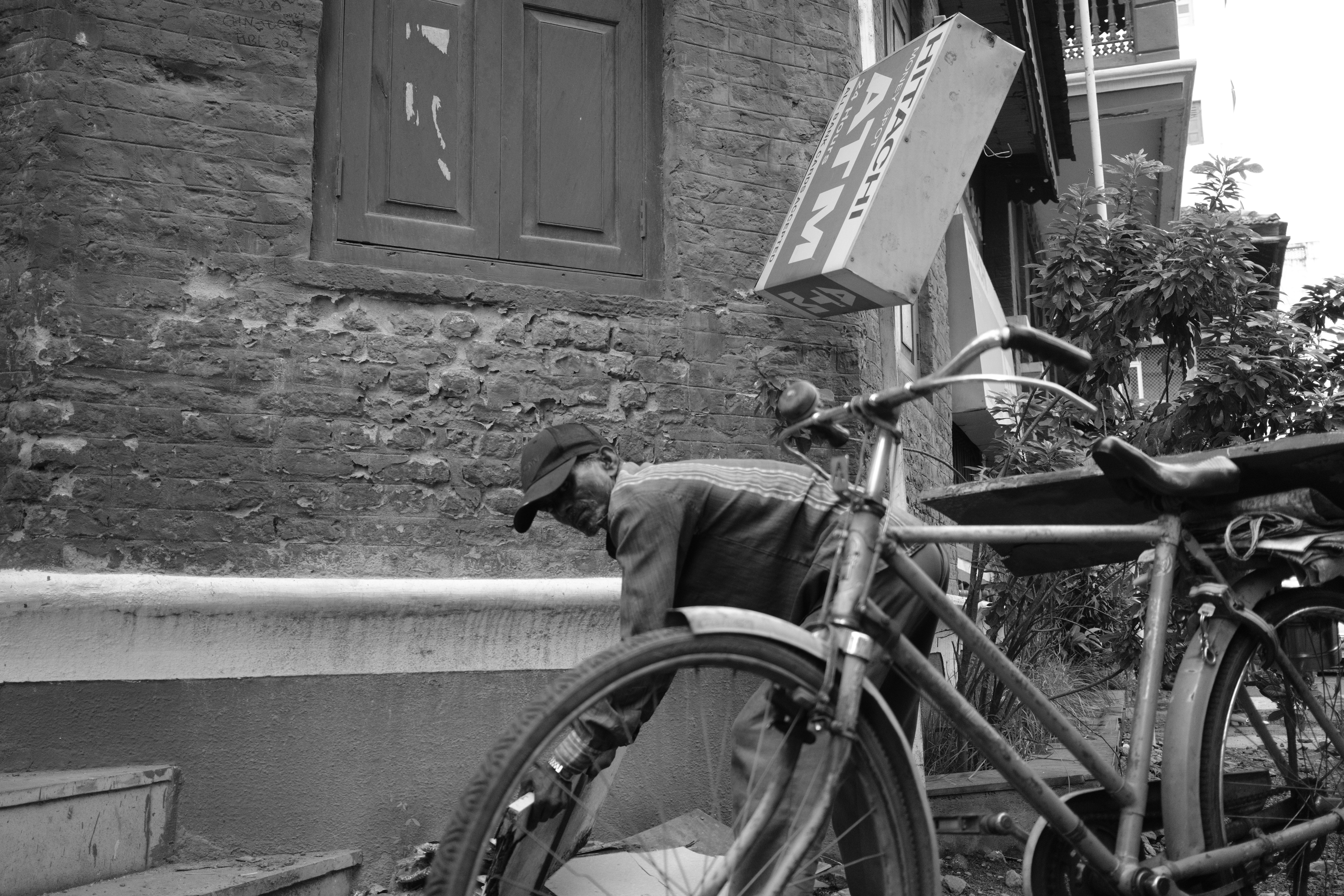 A Quiet Step: Streetwise Bicycle and Shadowed Worker