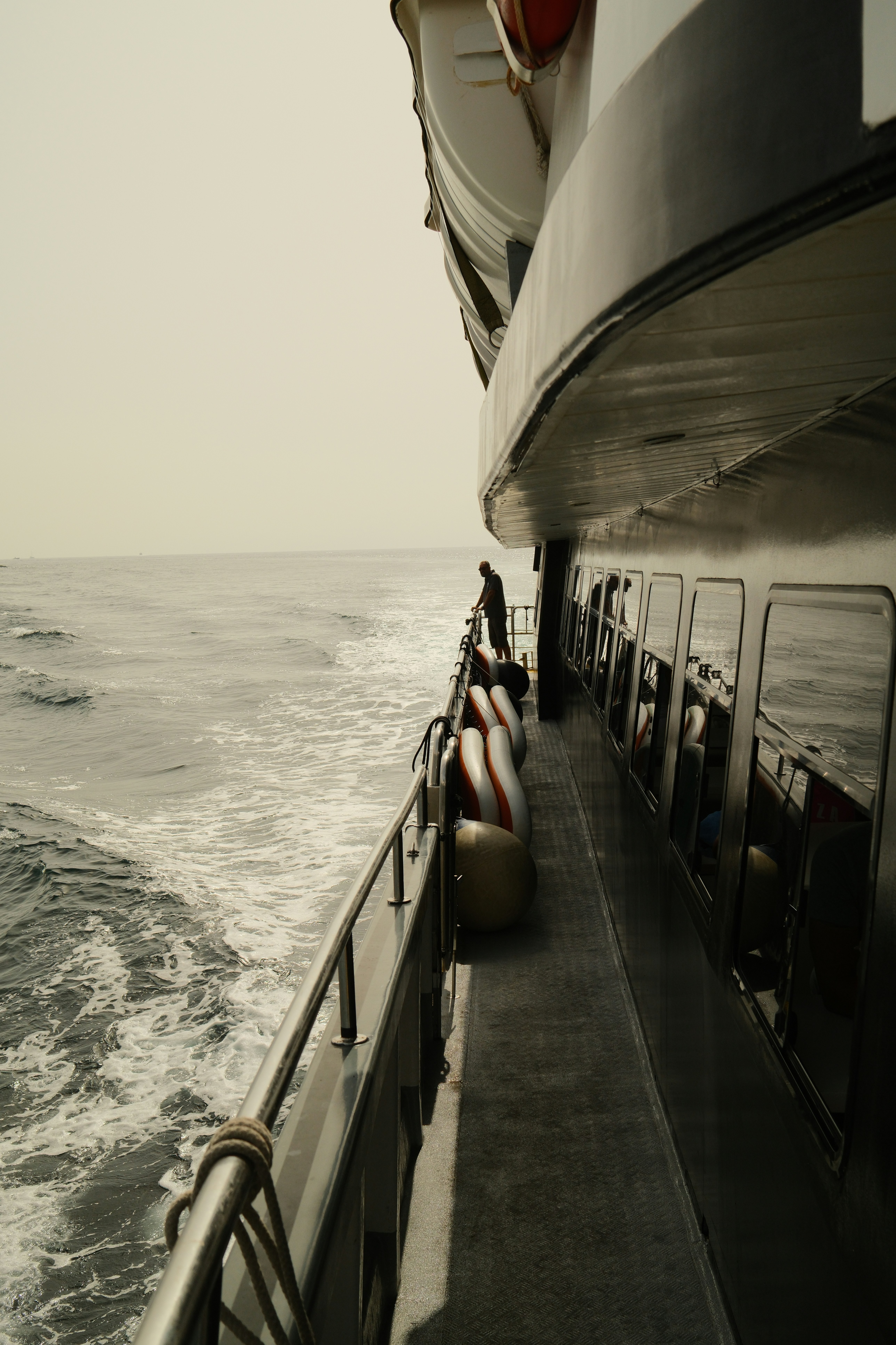 Deck Perspective: A Passenger Walks the Line Between Sea and Structure