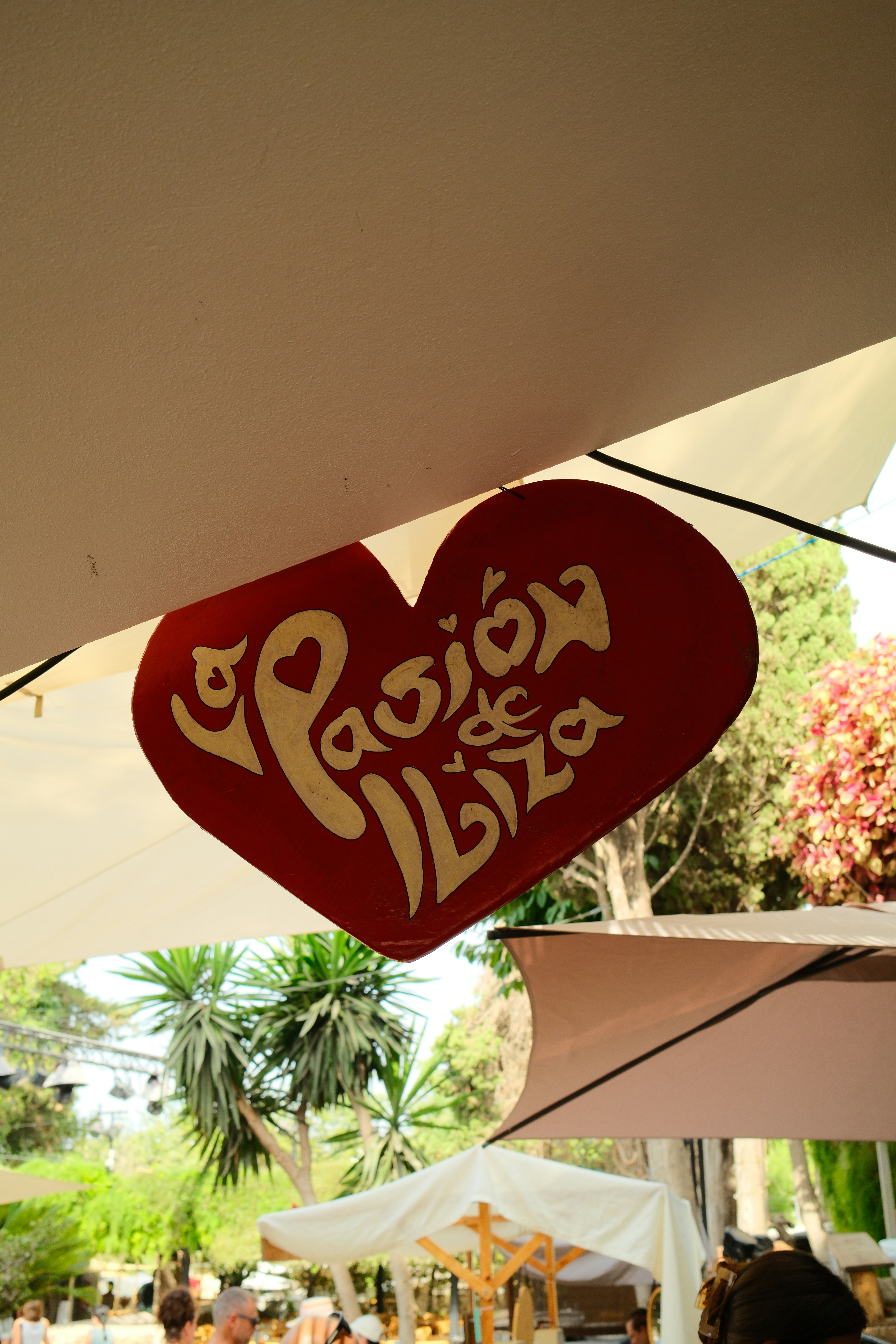 Heart Banner Over Patio: A Warm Day at a Café Scene
