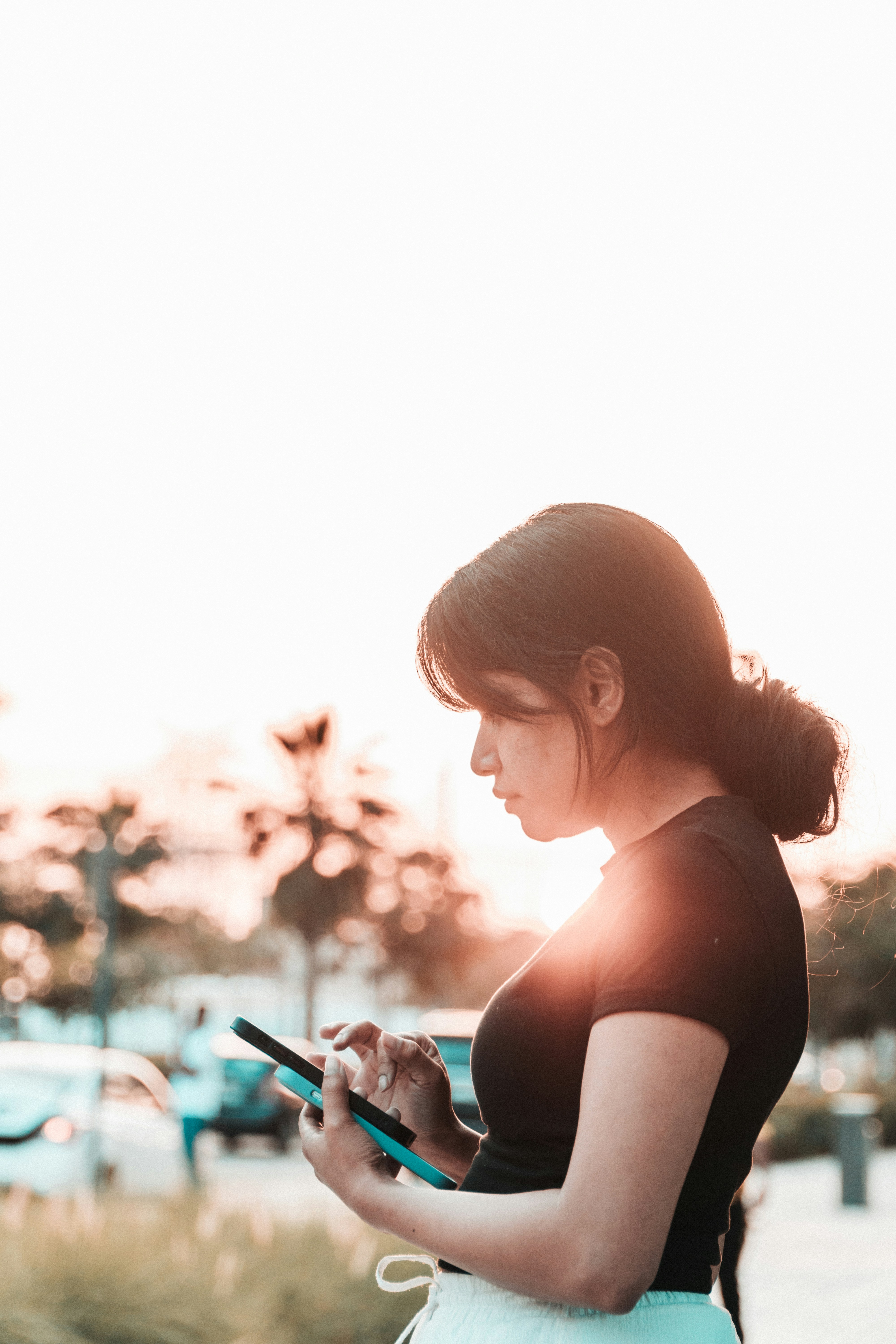Soft Backlight Portrait of a Woman with Tablet in Hand