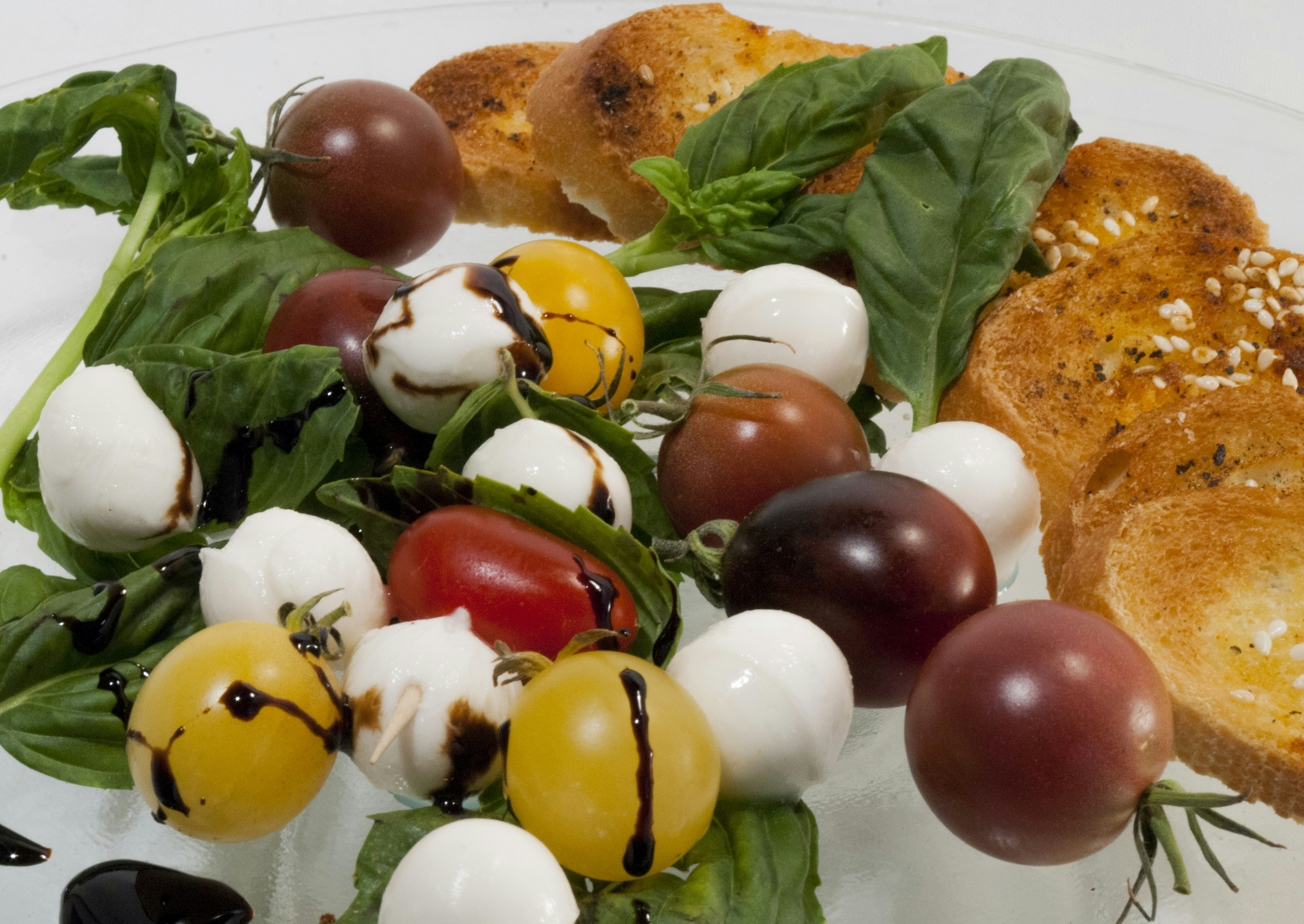 Caprese Salad with Cherry Tomatoes and Fresh Basil, drizzled with Balsamic Vinegar