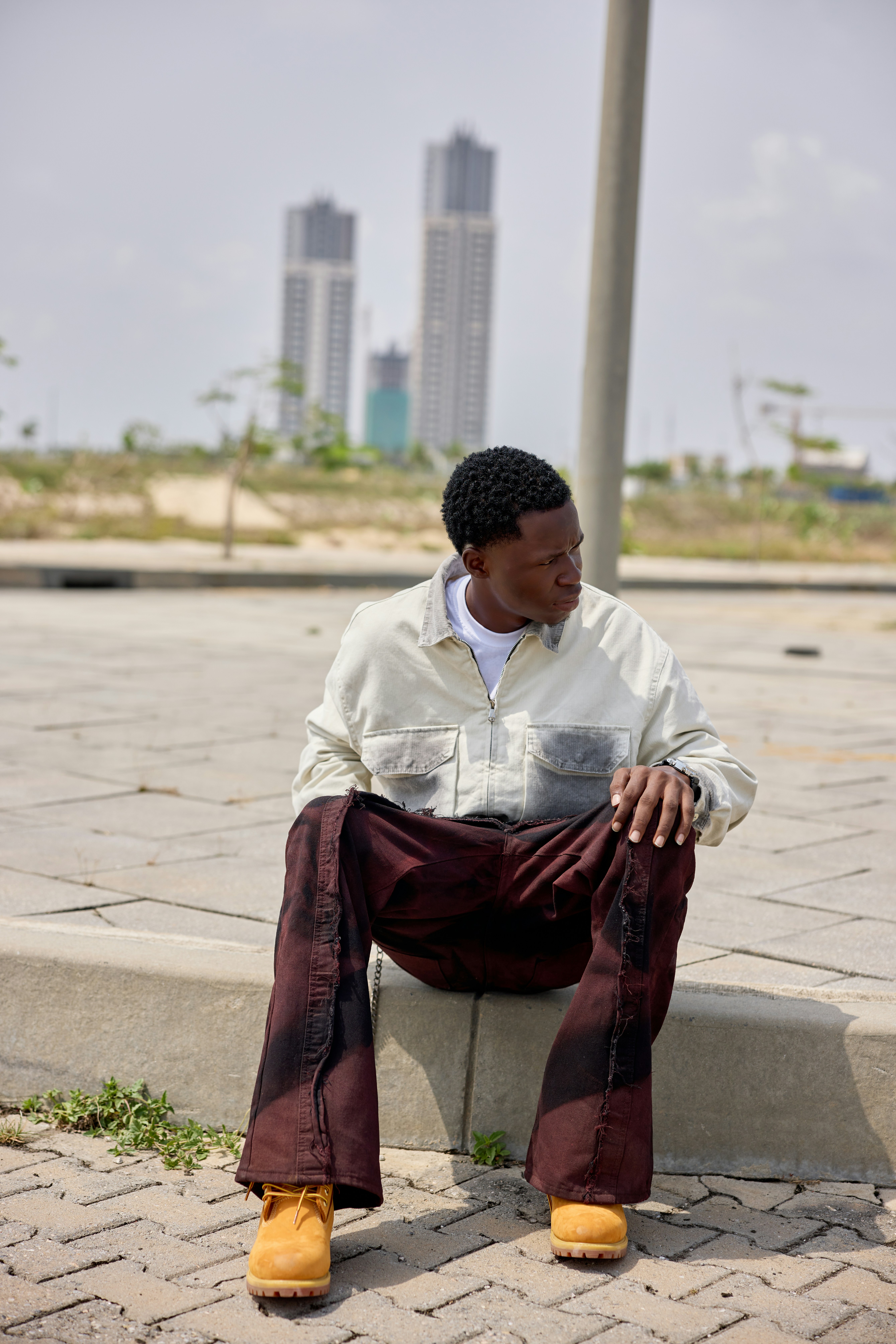 City Edge Portrait: A Quiet Moment Between Concrete and Denim
