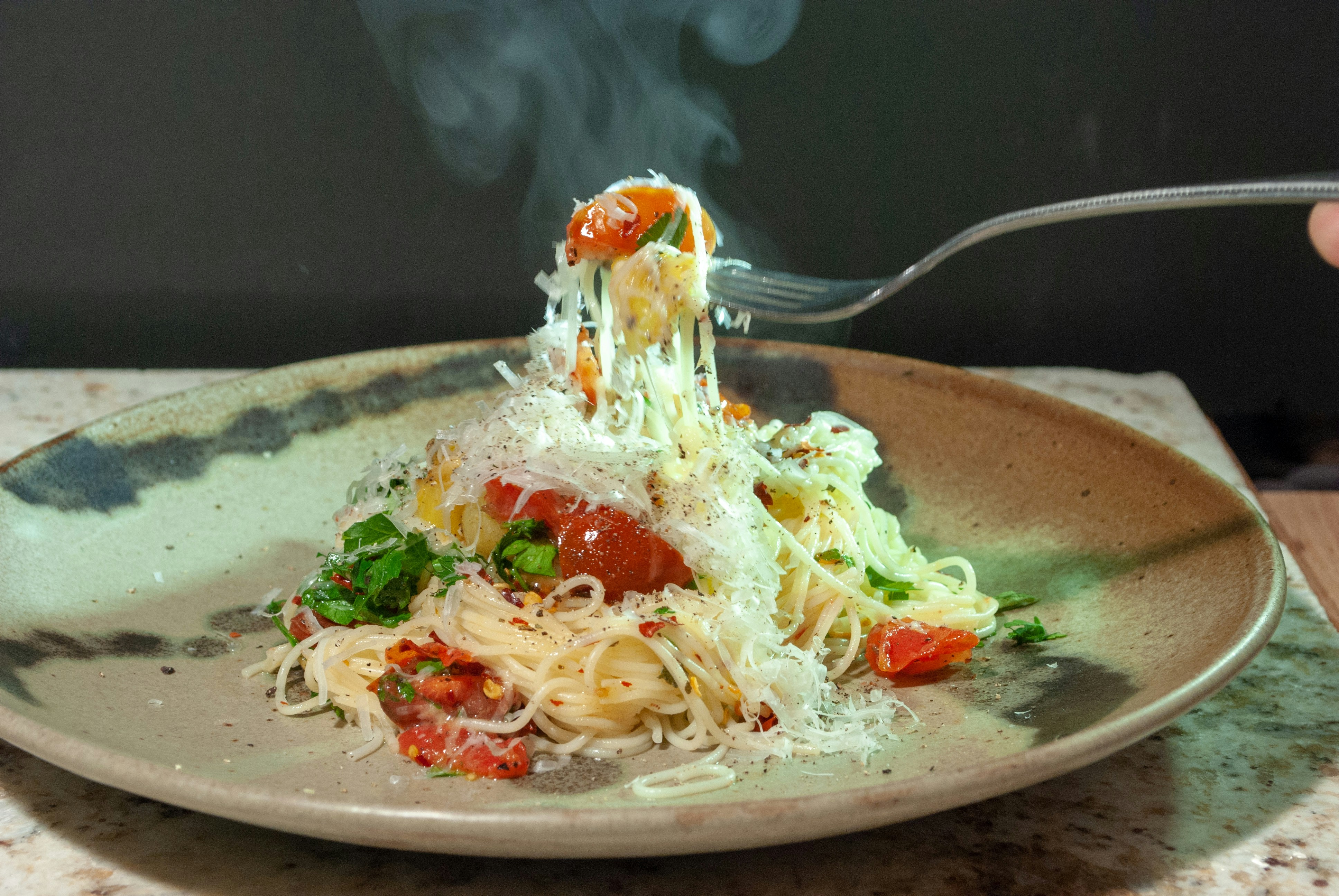 Steam and Spiral: A Plate Lifted by a Tangle of Parmigiano