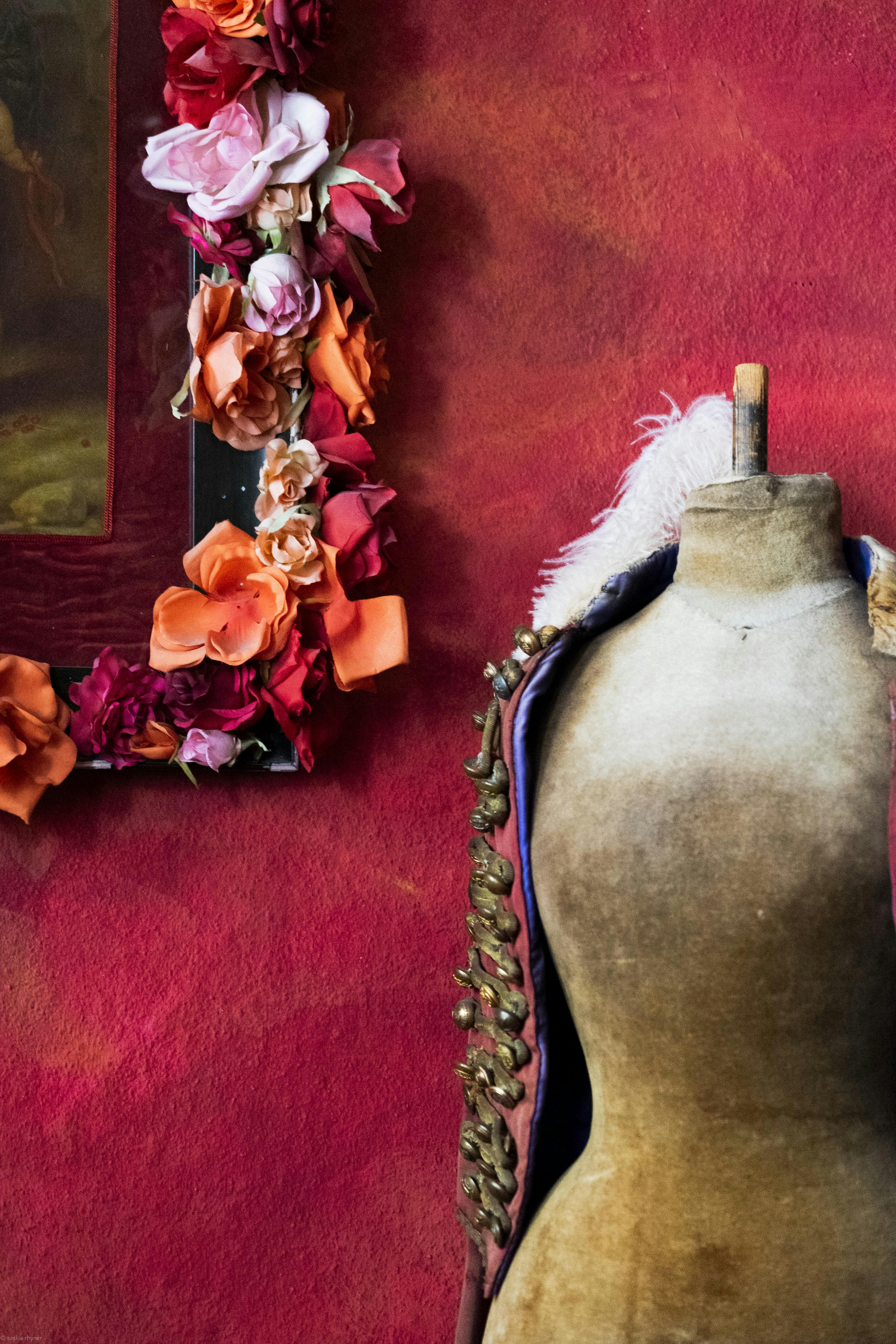Floral Trim and Corseted Mannequin: A Still Life of Velvet Red and Craft Details