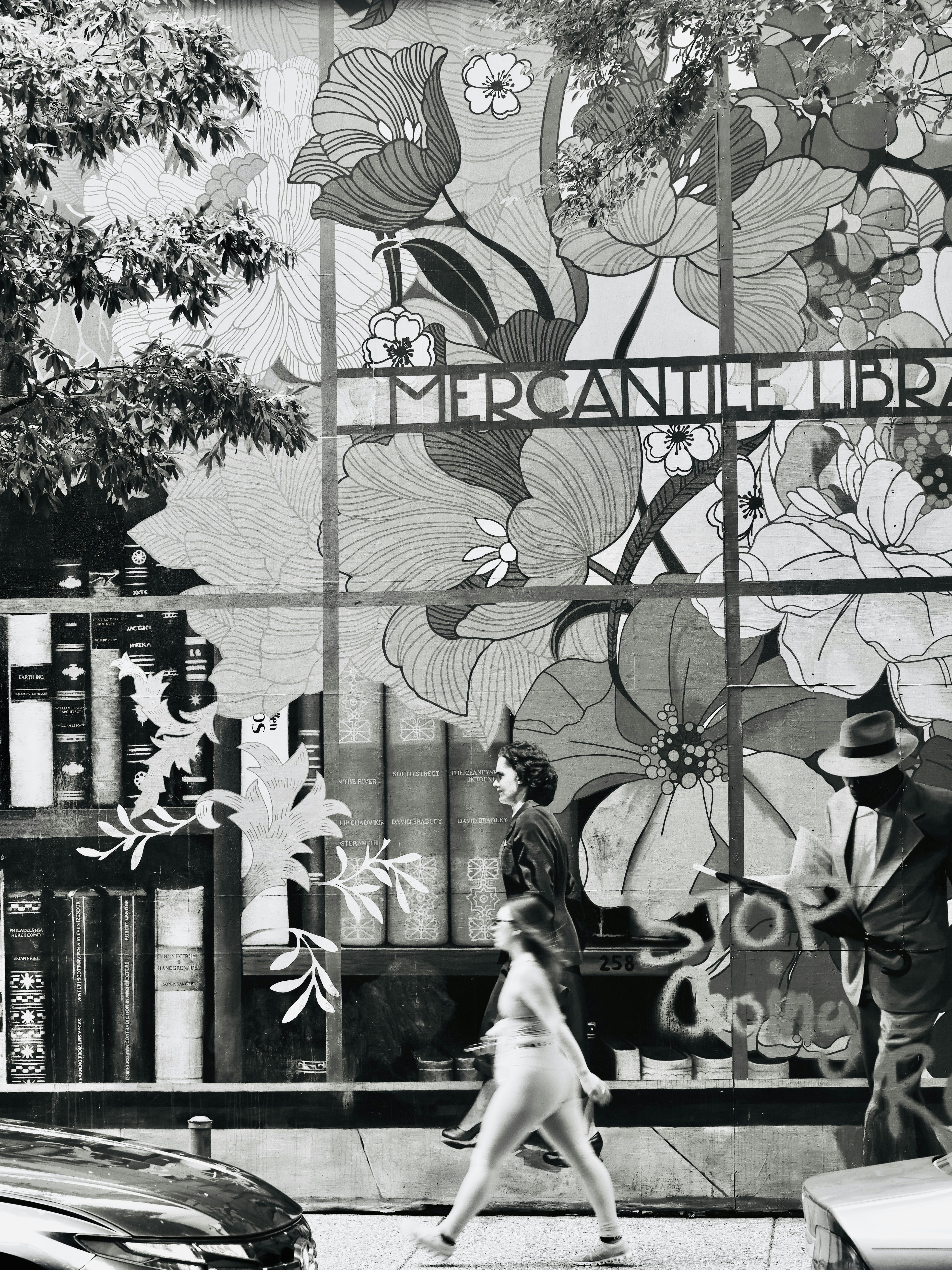 Graffiti Gallery on a City Street: People in Front of Floral Mural