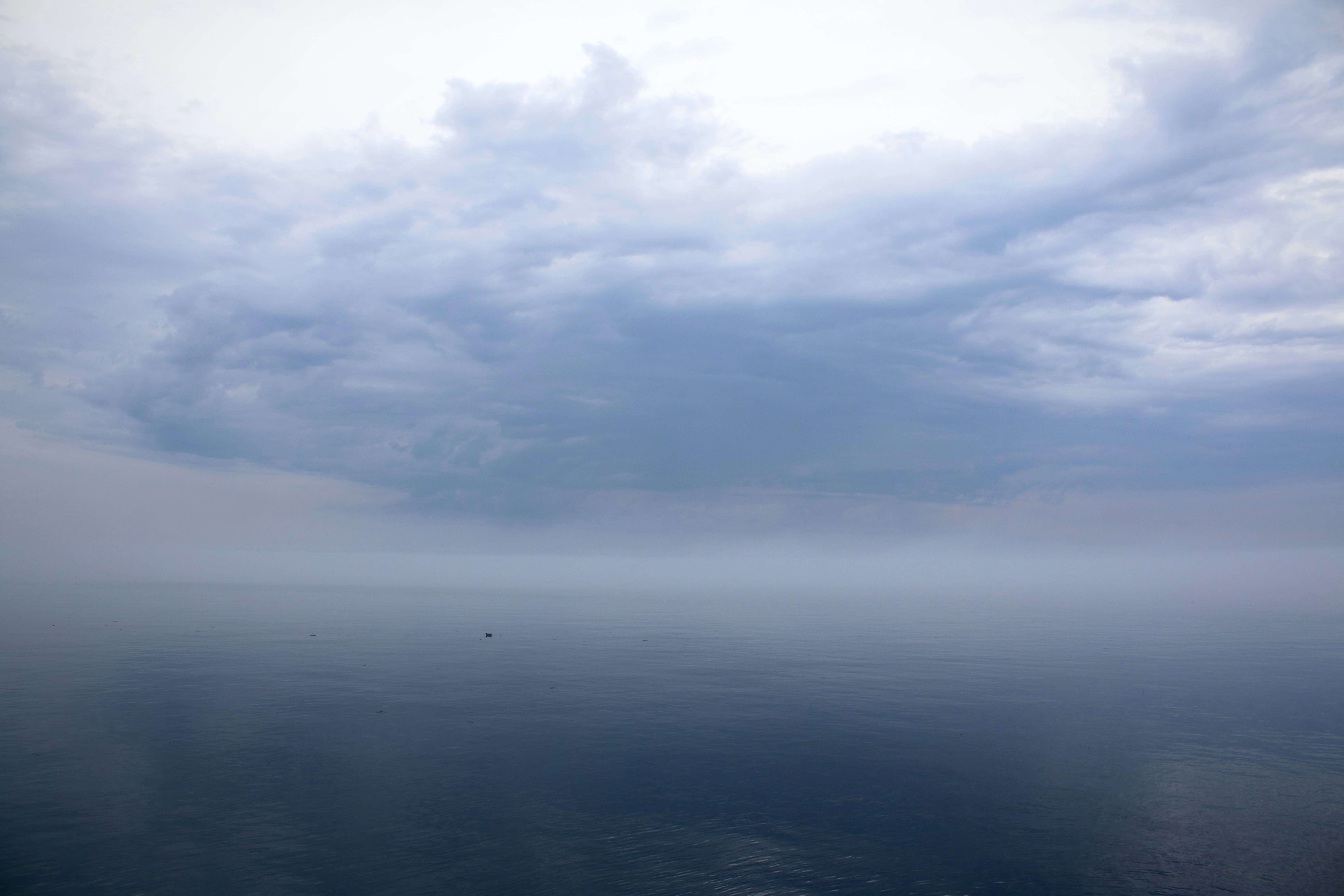 Muted Horizon: A Quiet Sea Under Overcast Skies