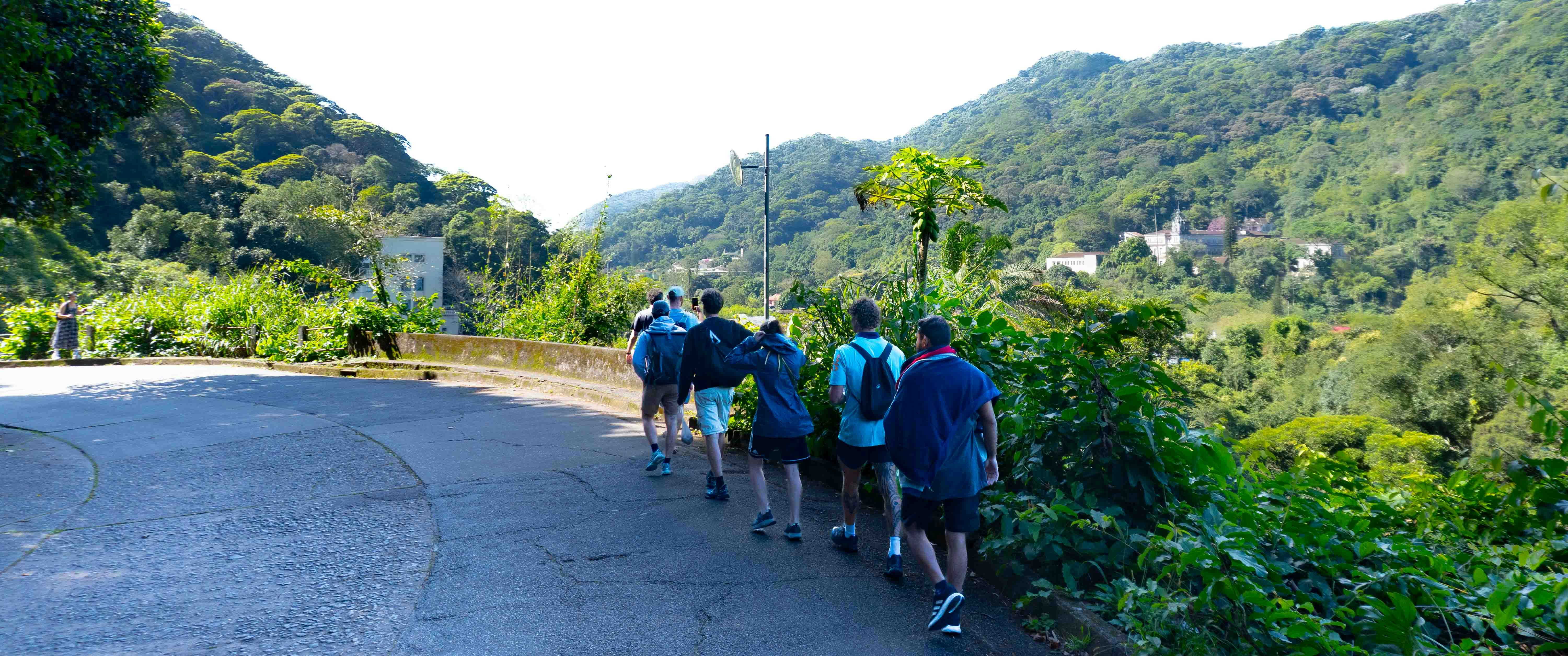 Hilltop Hike: A Row of Backpackers on a Warming Ridge Road