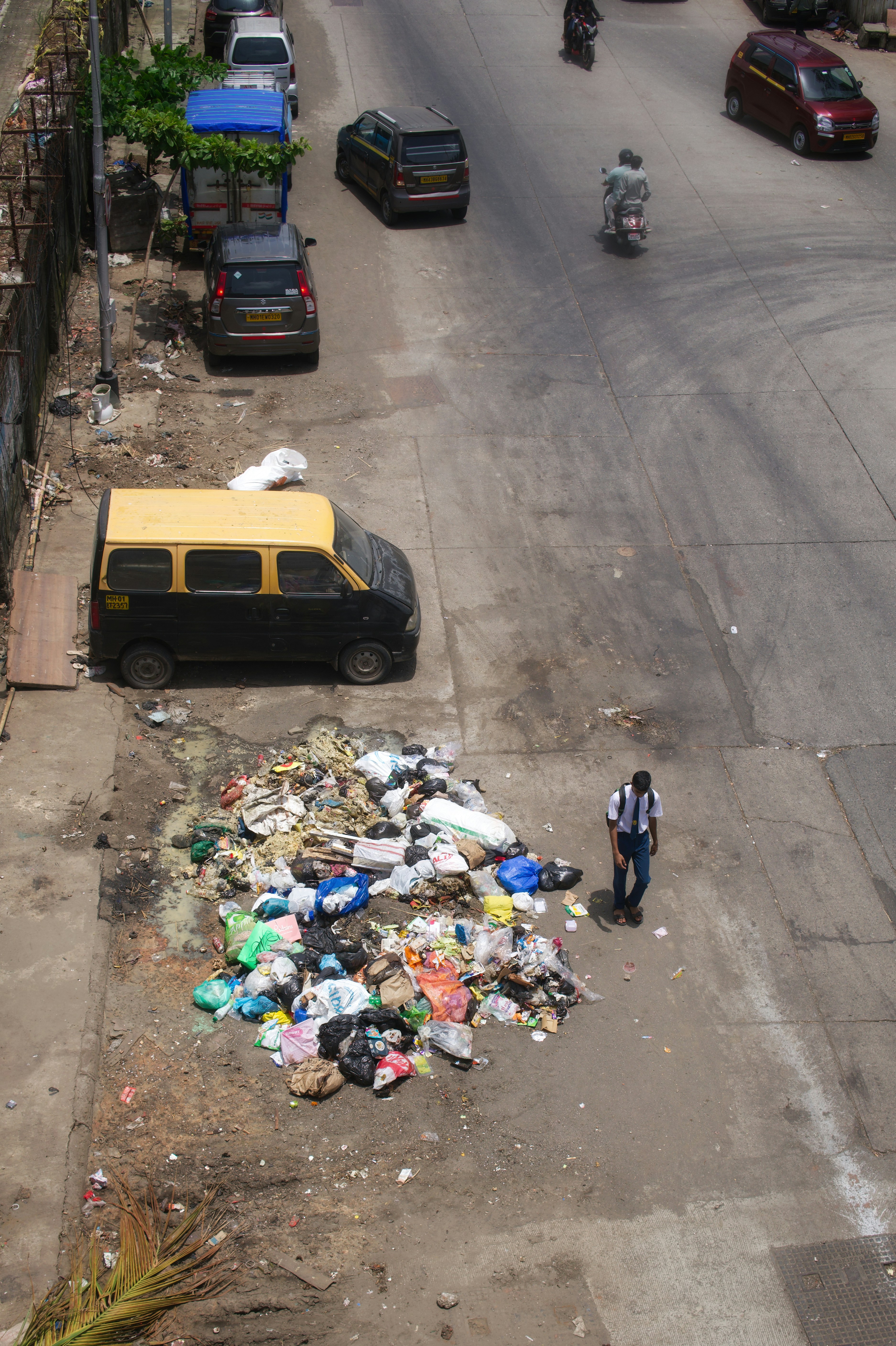 Street on the Edge: A Yellow-Black Van and Pile of Trash, Front-Weighty Scene