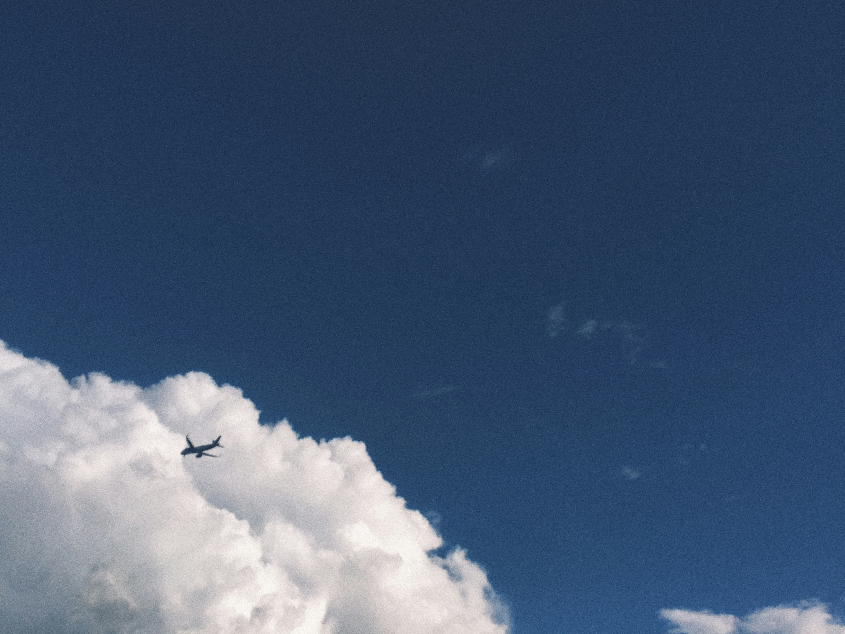 Airliner against a sculpted cloud canopy