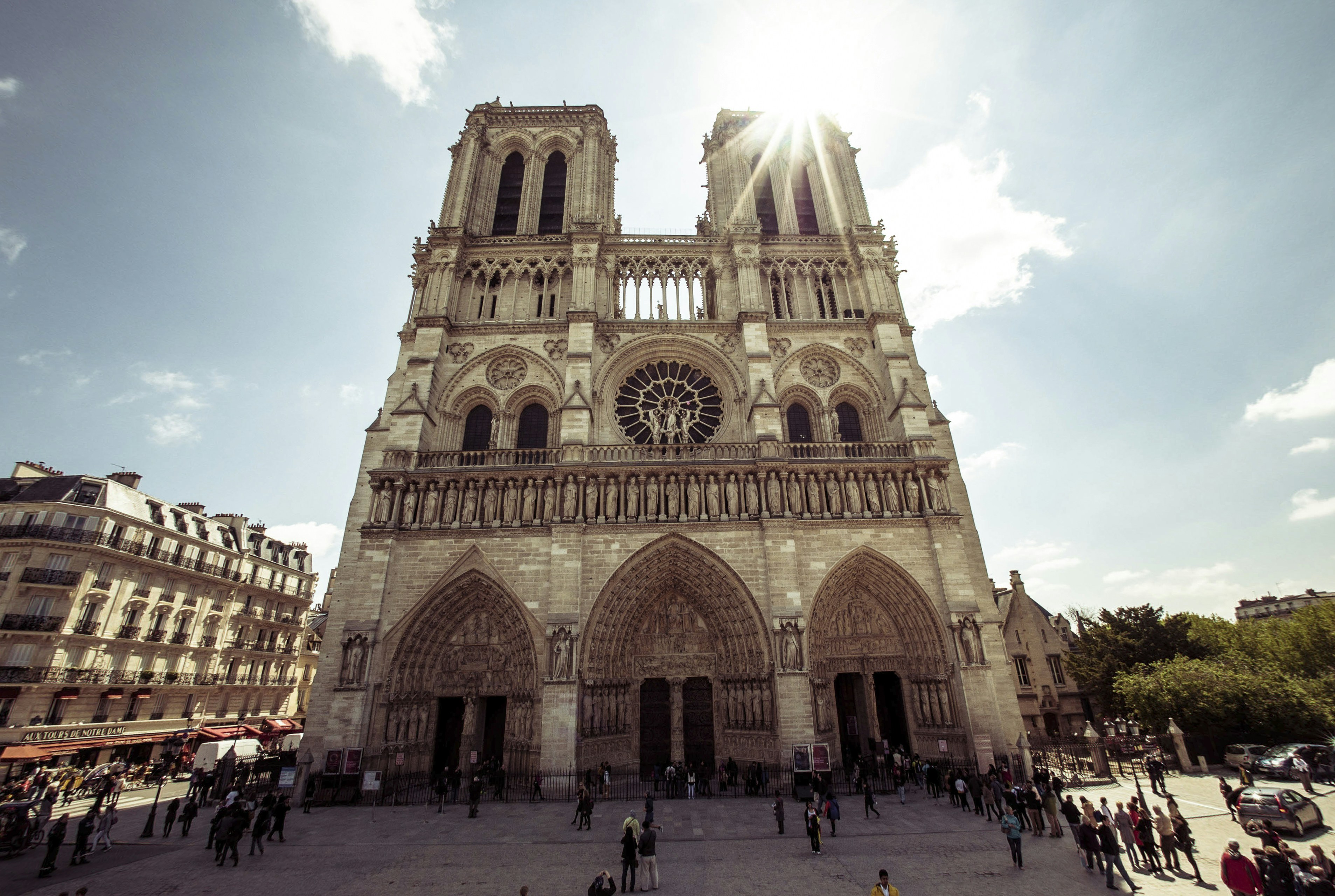 Front Facade of Notre-Dame Cathedral with Sunburst Over the Tower