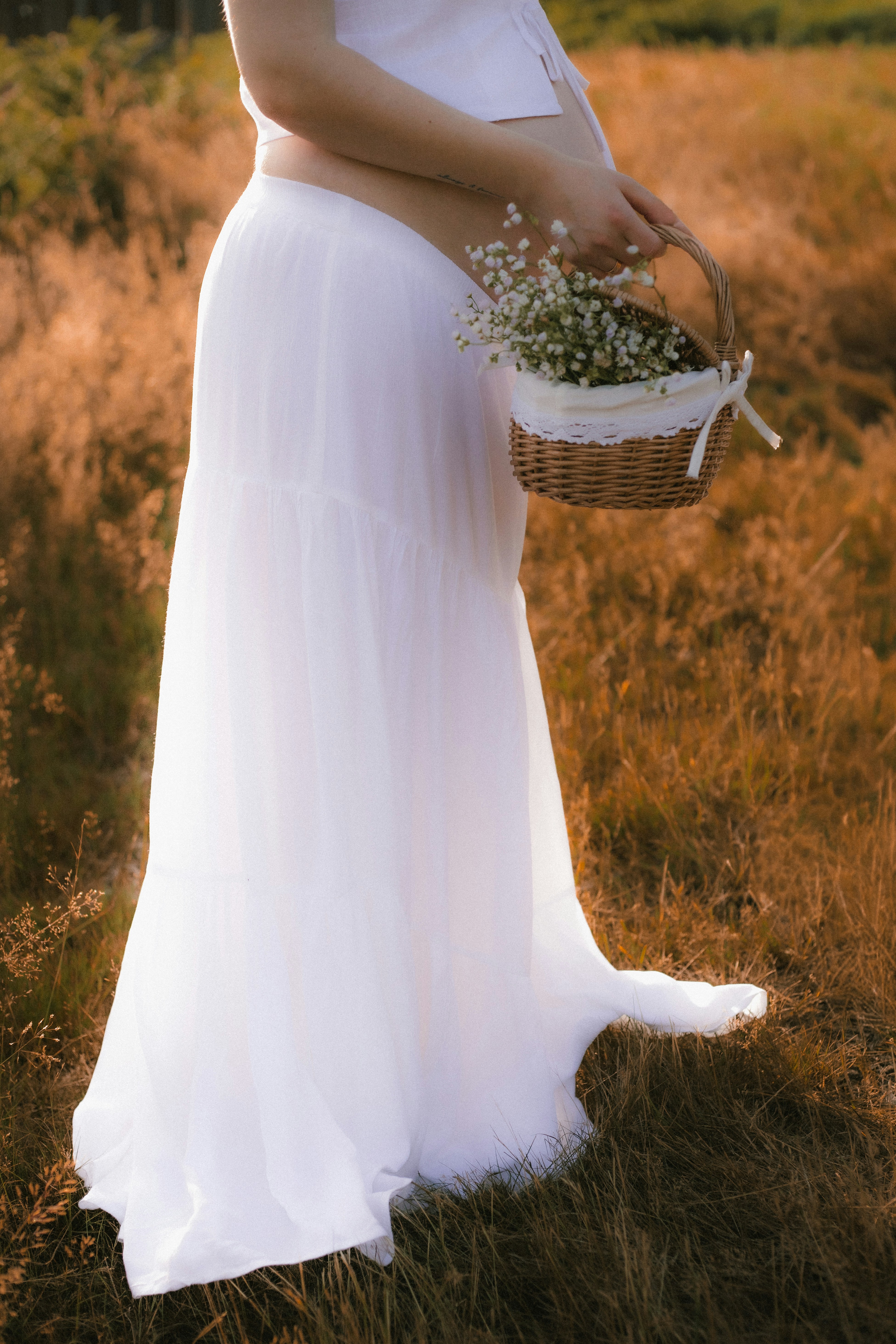 Gentle Expectation: A Pregnant Silhouette in Spring Light