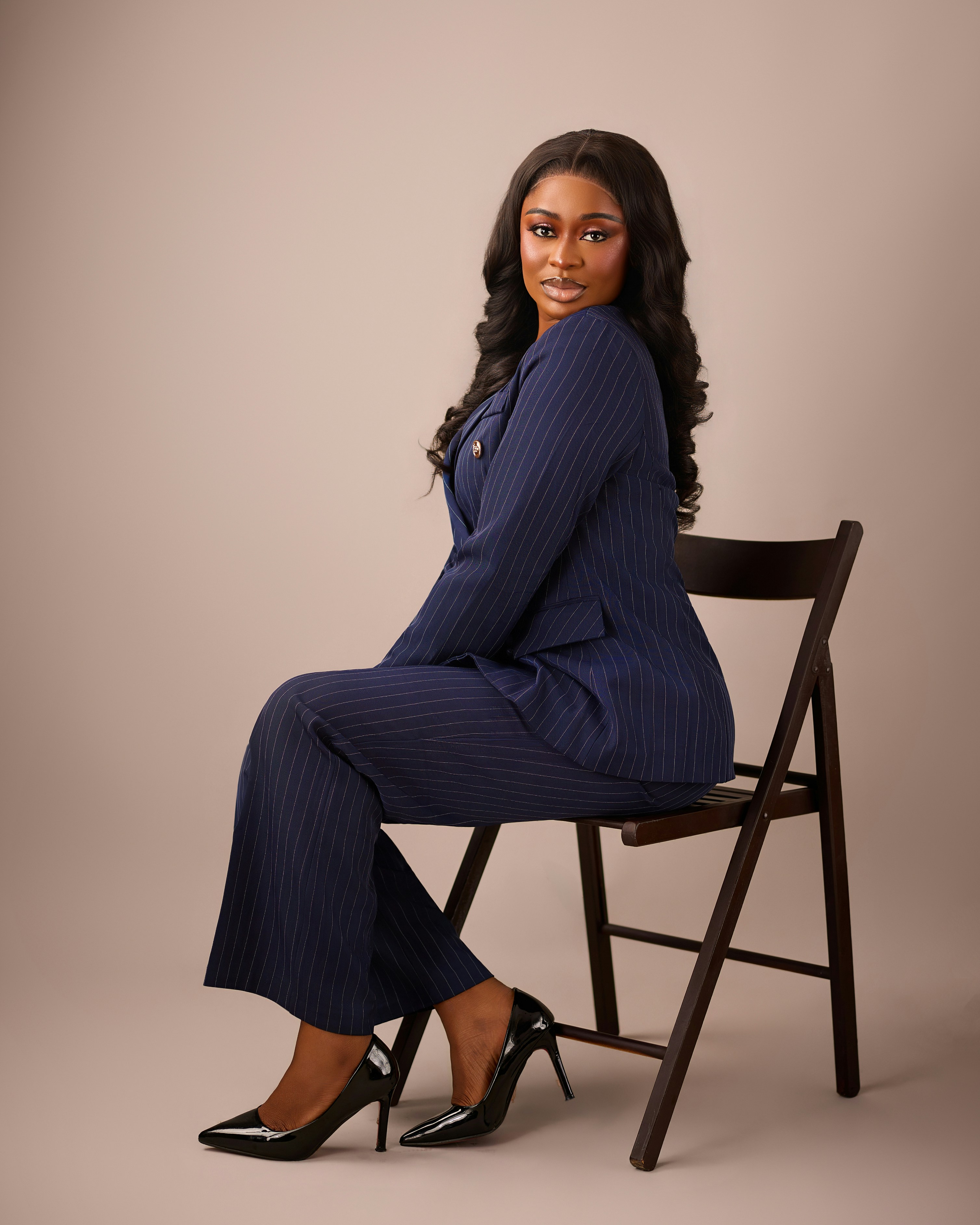 Stride in Pinstripe: A Poised Portrait on a Quiet Set