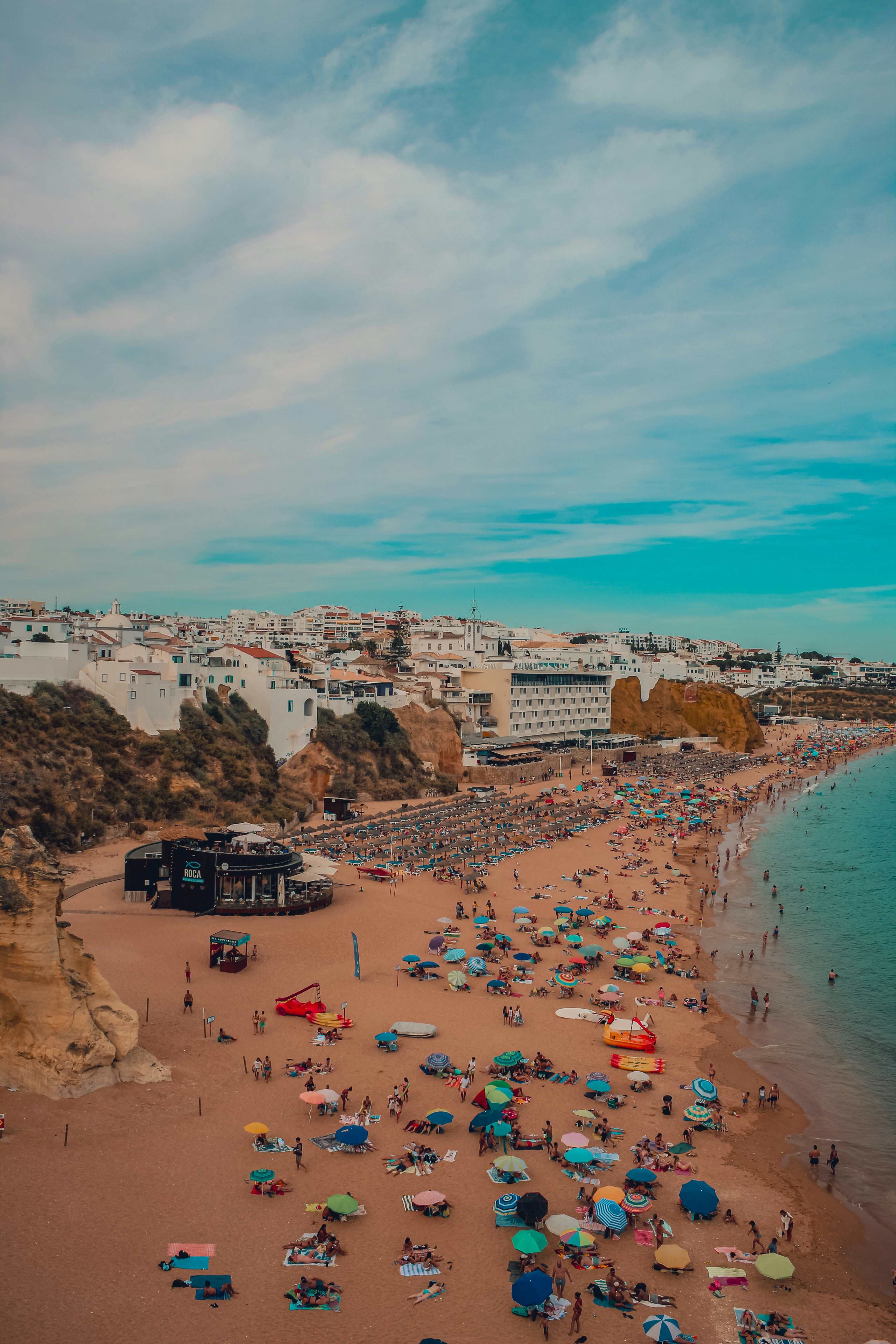 Sunlit Beachside Village: A Paintbox of Umbrellas and Waves