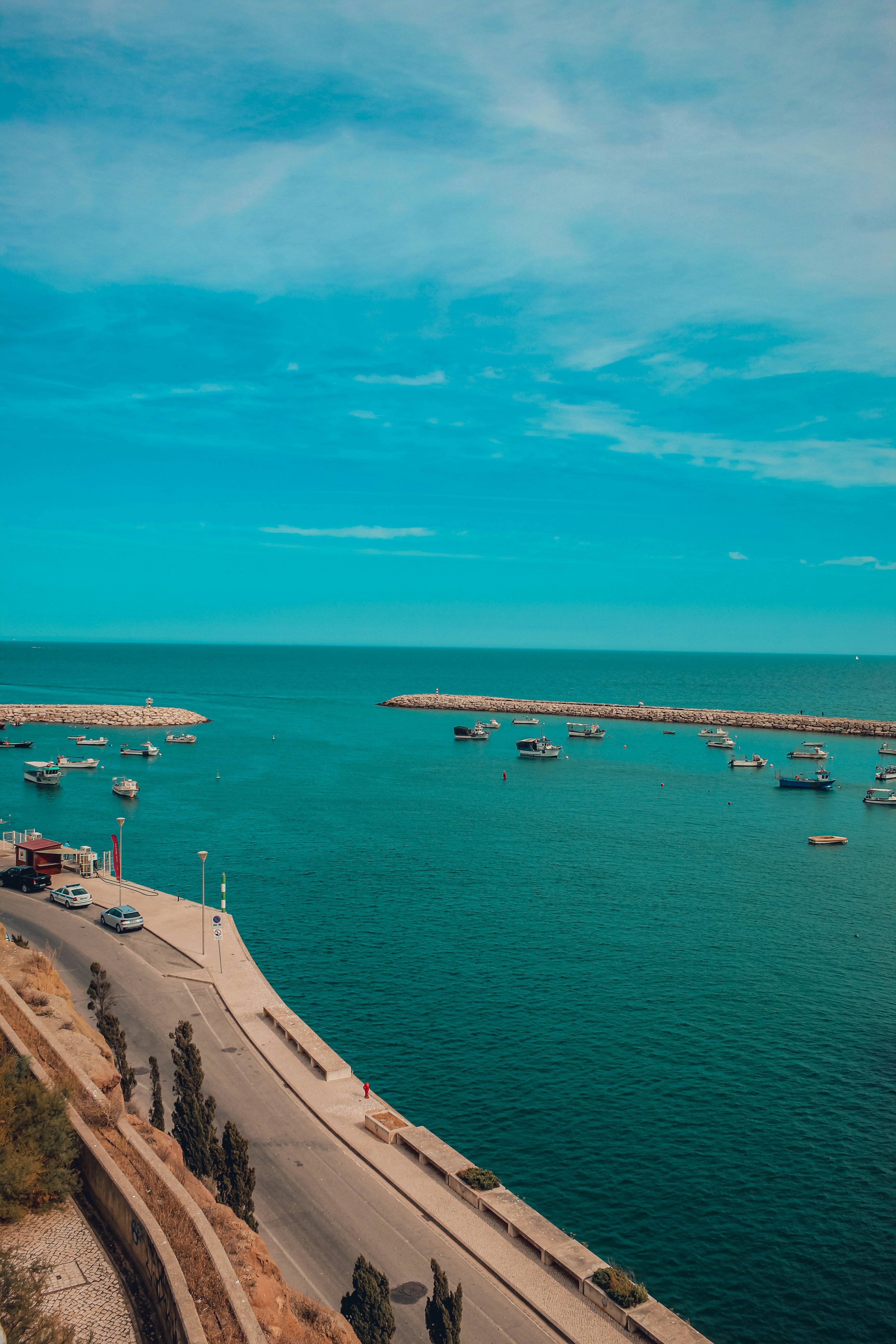 Harbor Curve: A coastal road toward the calm turquoise sea
