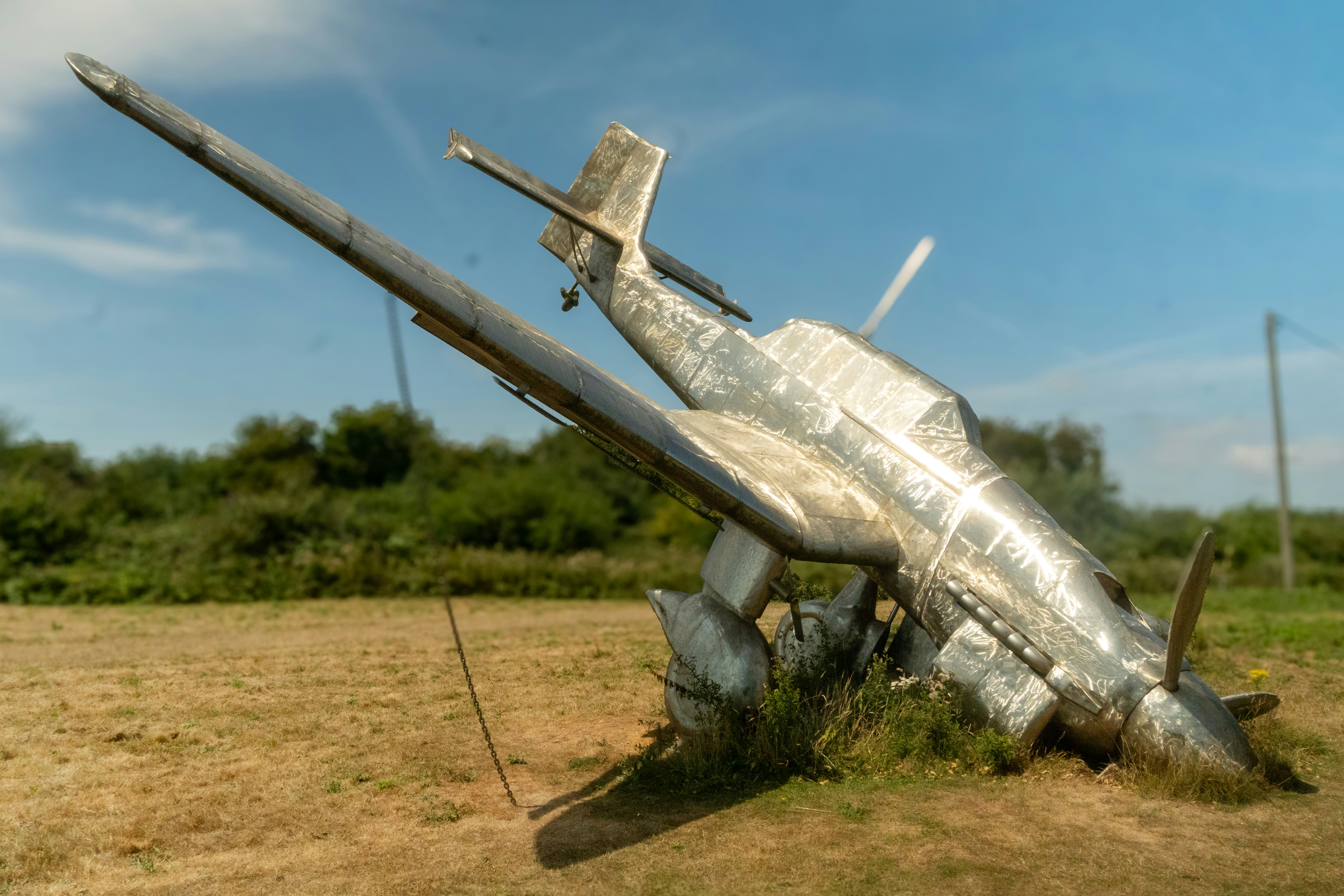 Illicit Wings: A Weathered Warbird Resting in the Dust