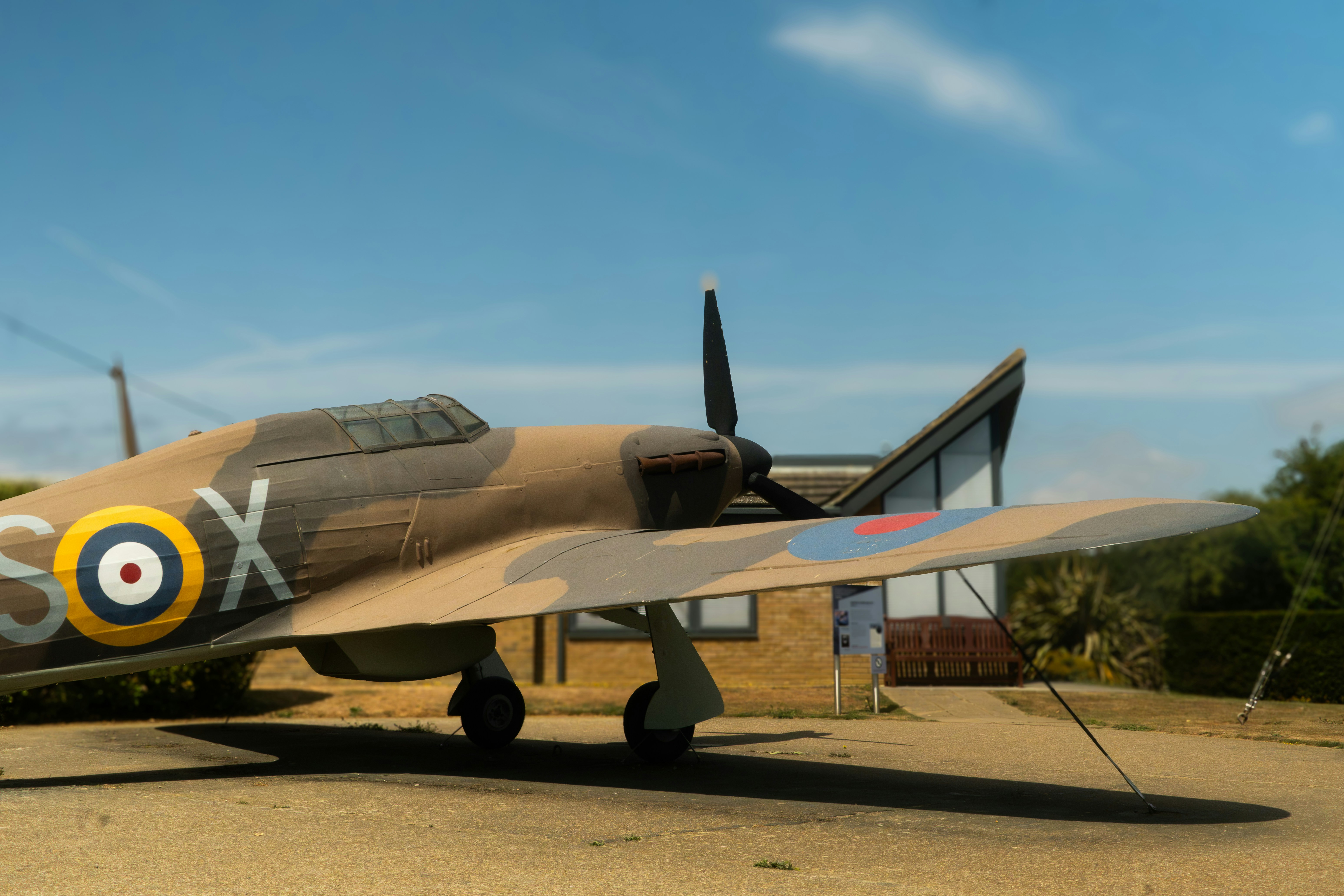 Dawn at the Wings: A Vintage Warbird Resting in the Sunlit Courtyard