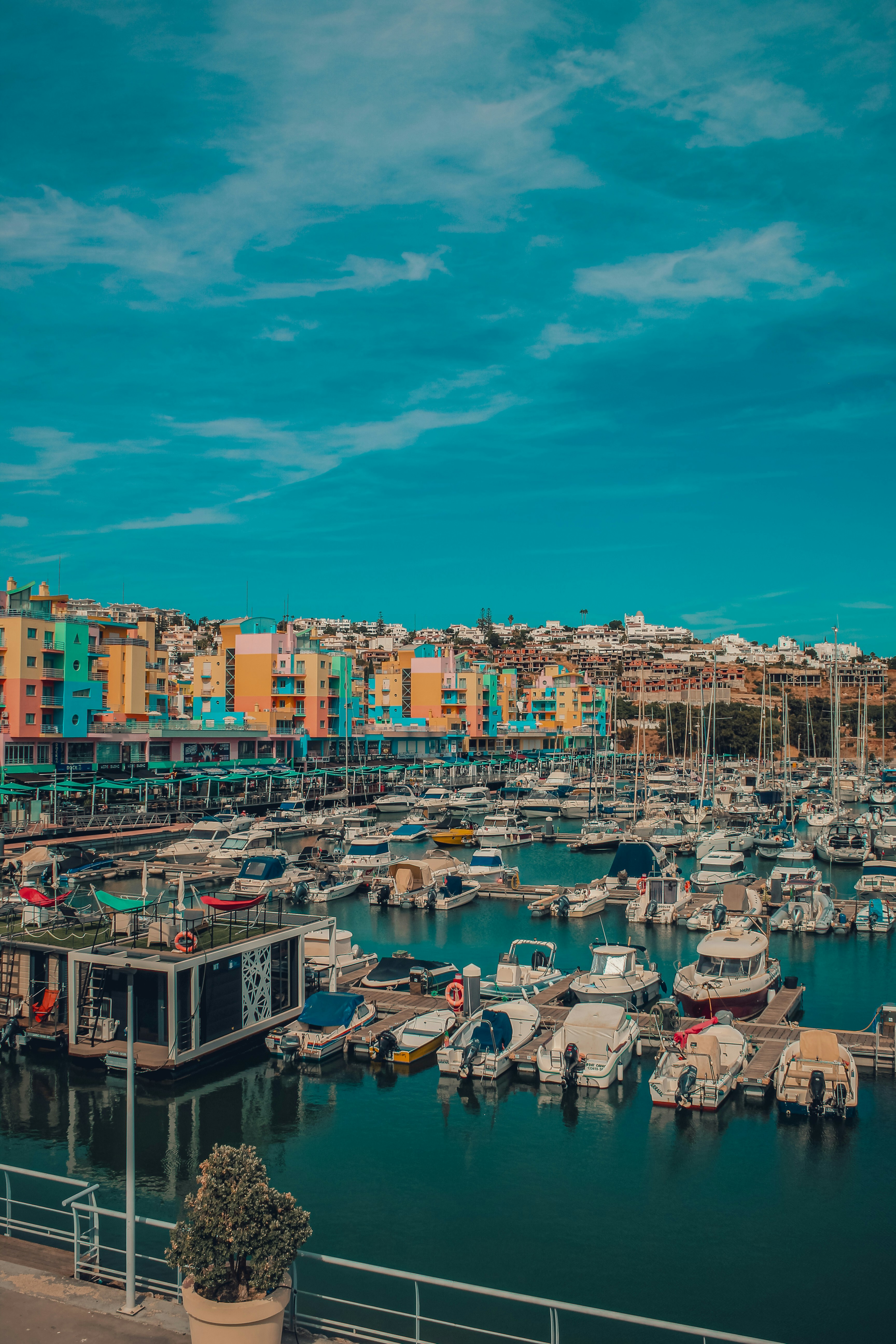 Colorful Marina Horizon: Boats Docked Against a Bright Coastal Town