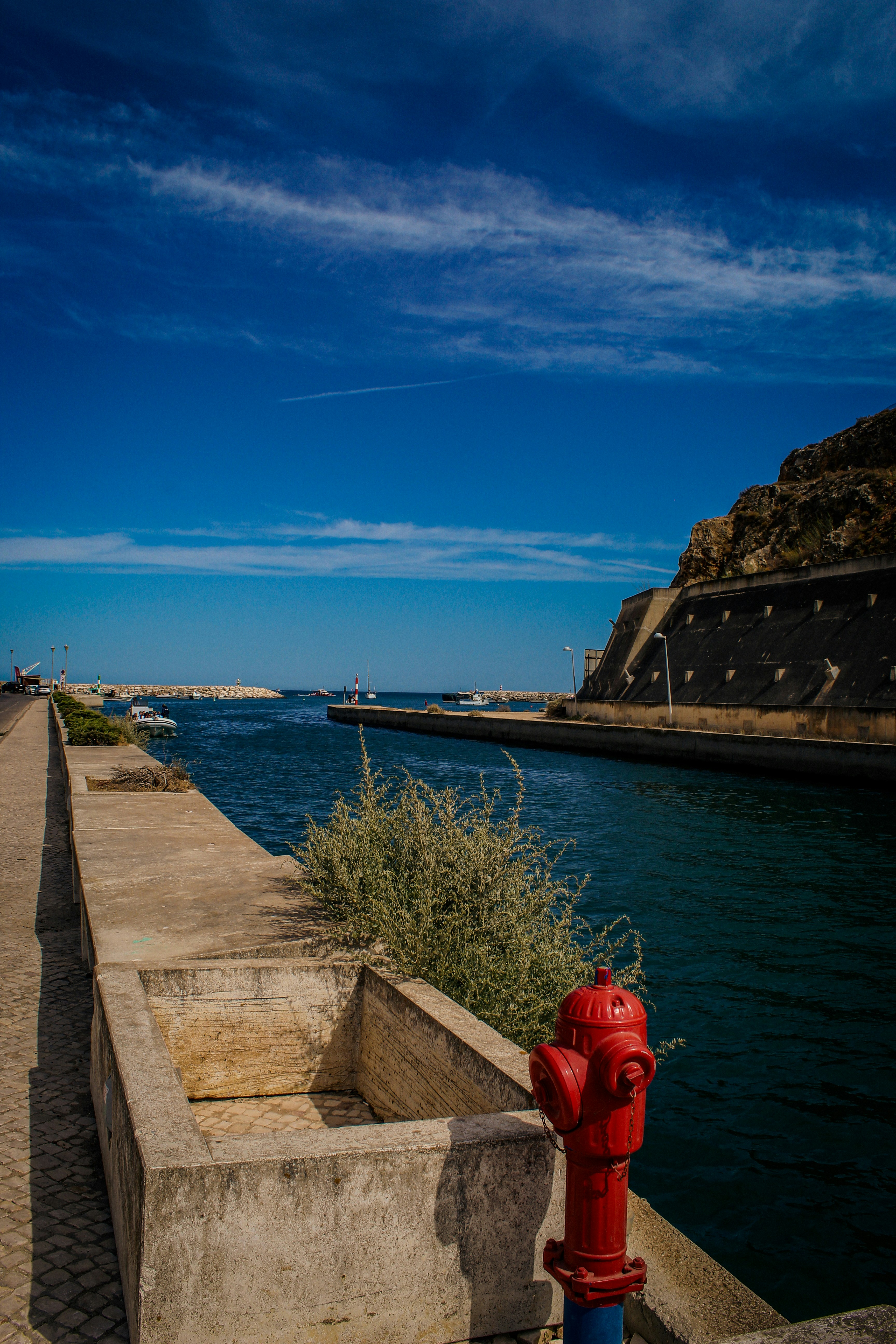 Red Fire Hydrant at the Pier: A Quiet Port Vista