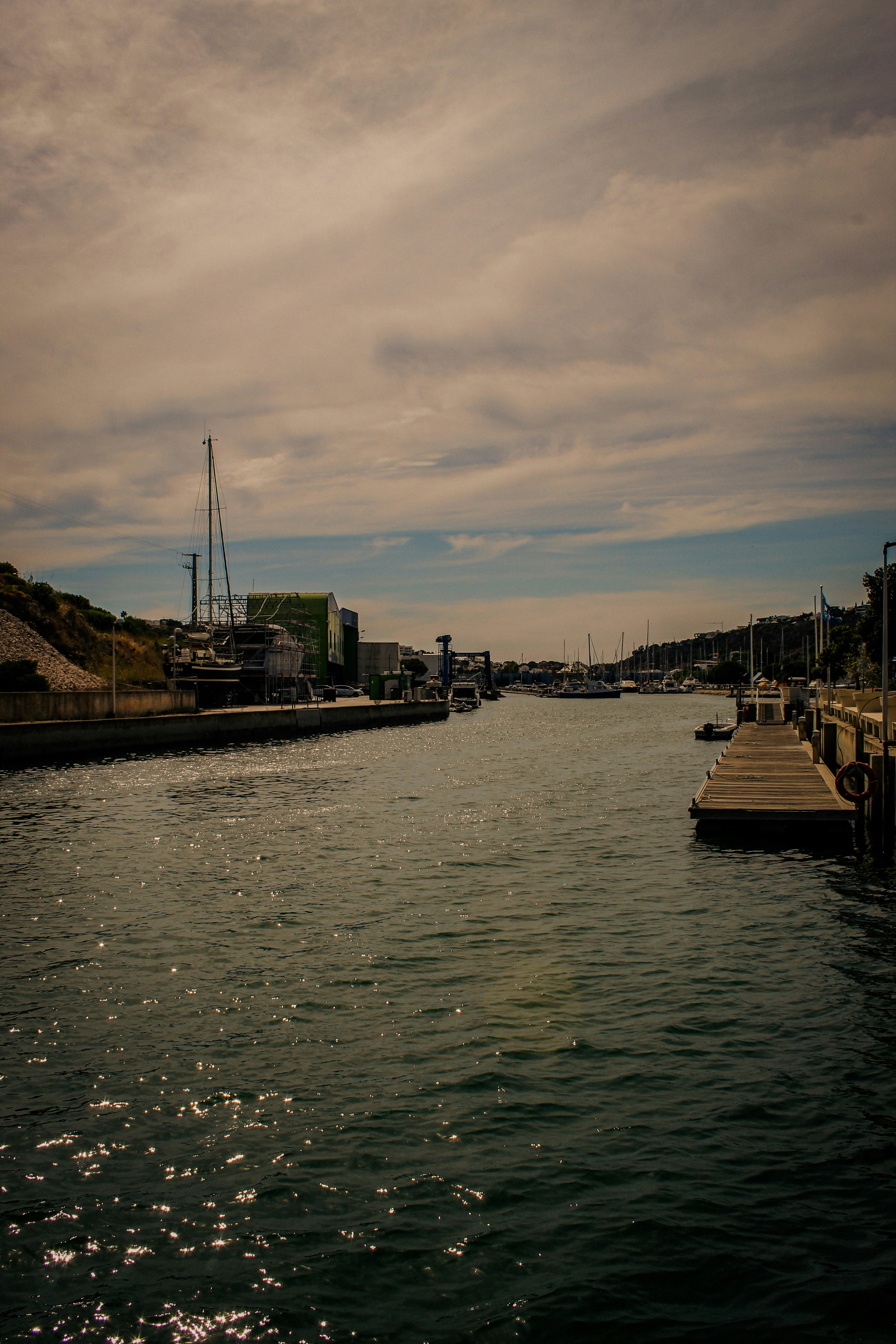Dusk by the Docks: Boats Lined Up Under Quiet Skies