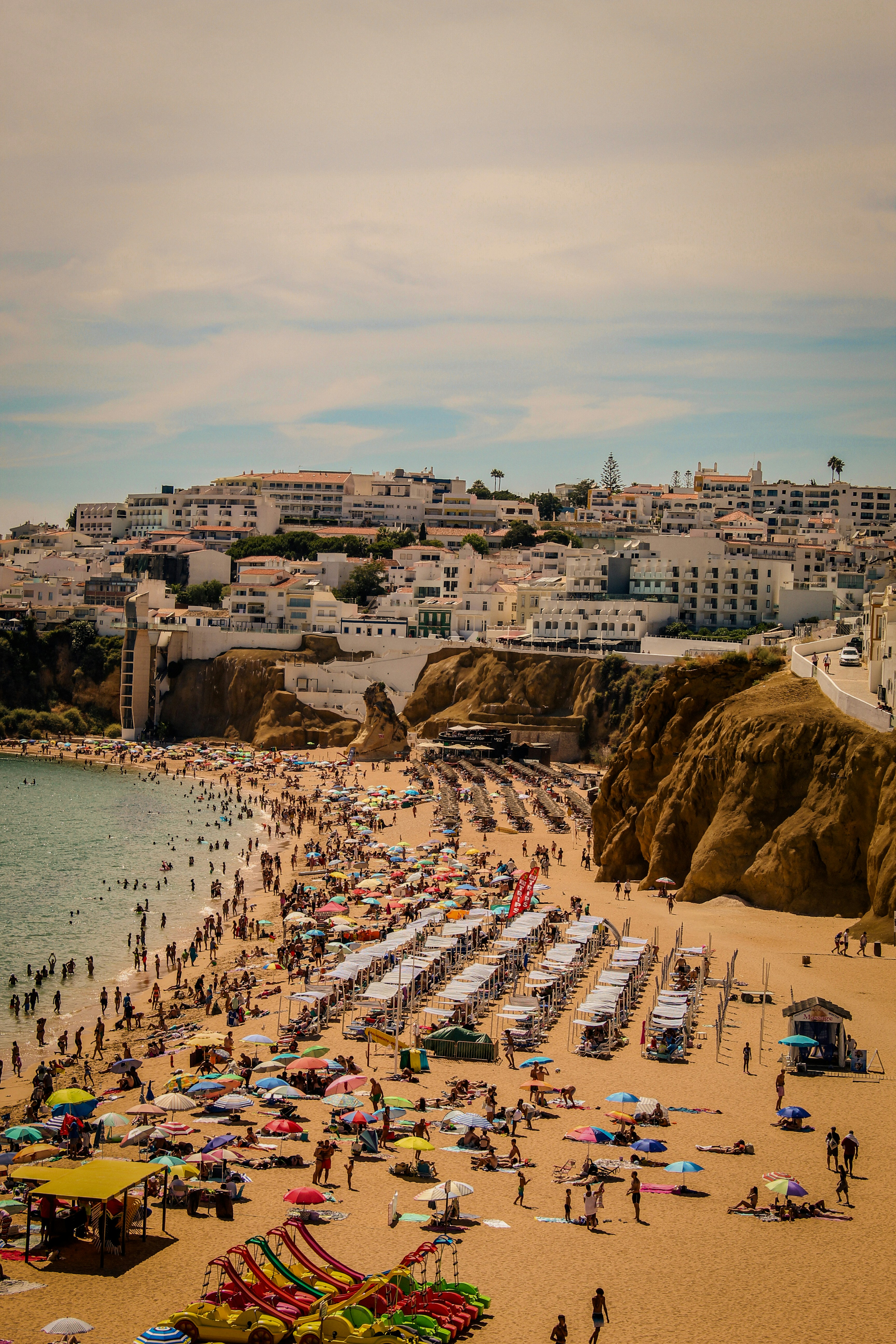 Sunlit Beachscape Beneath Coastal Cliffs