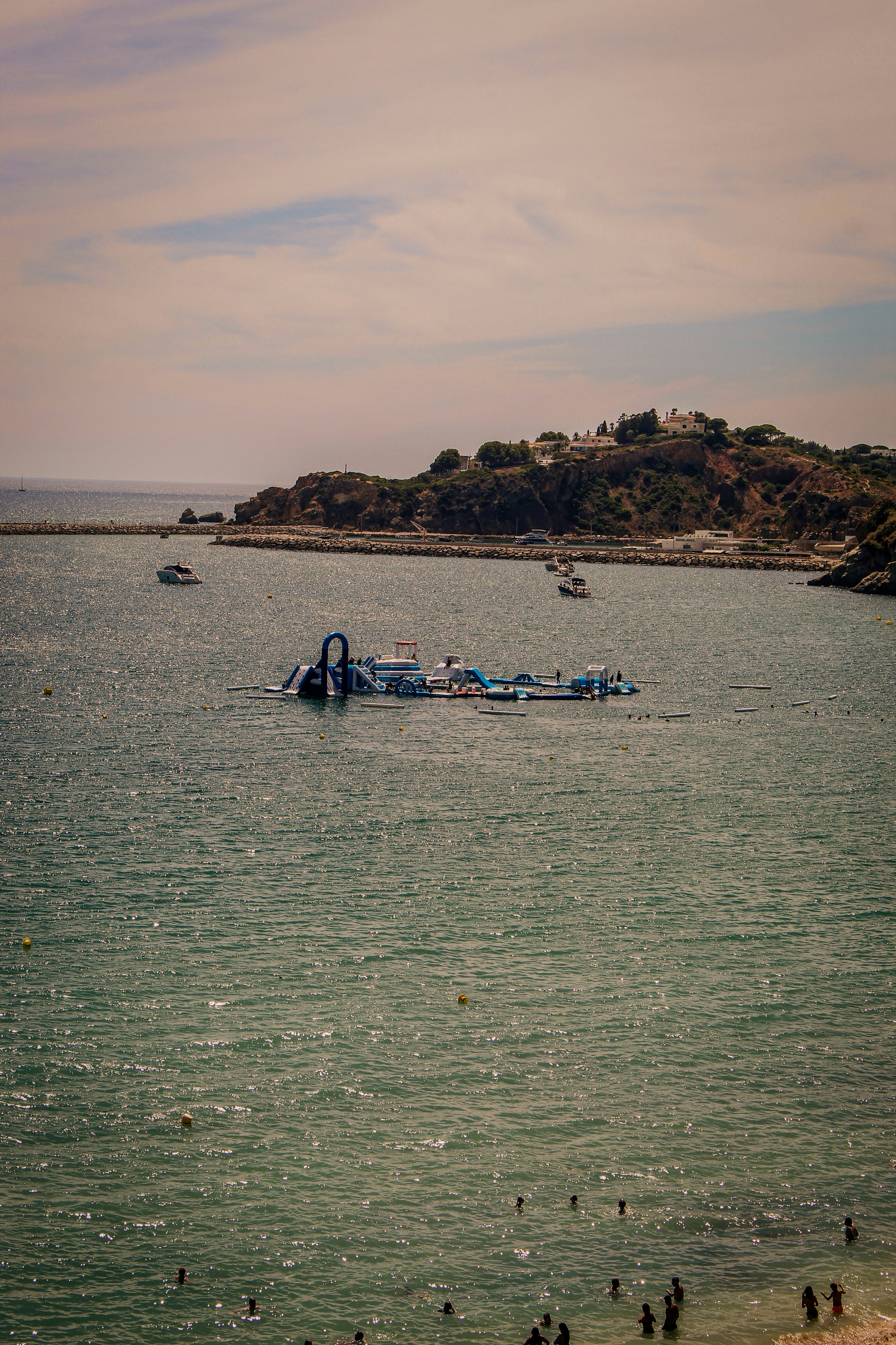 Harbor Boats at Dusk: Quiet Sea Beneath a Cliffside Village
