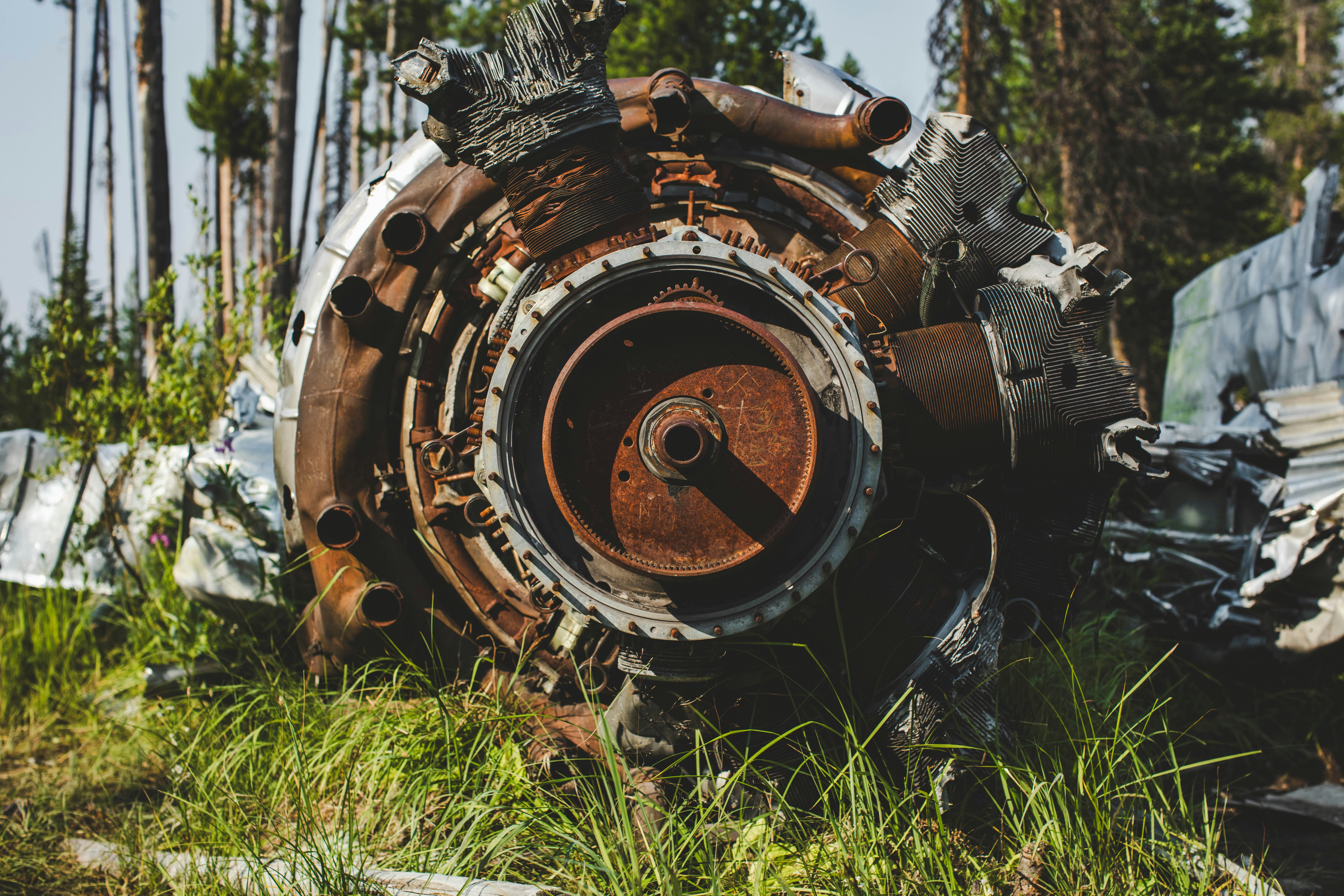 Rusty airplane engine wreckage in a forest