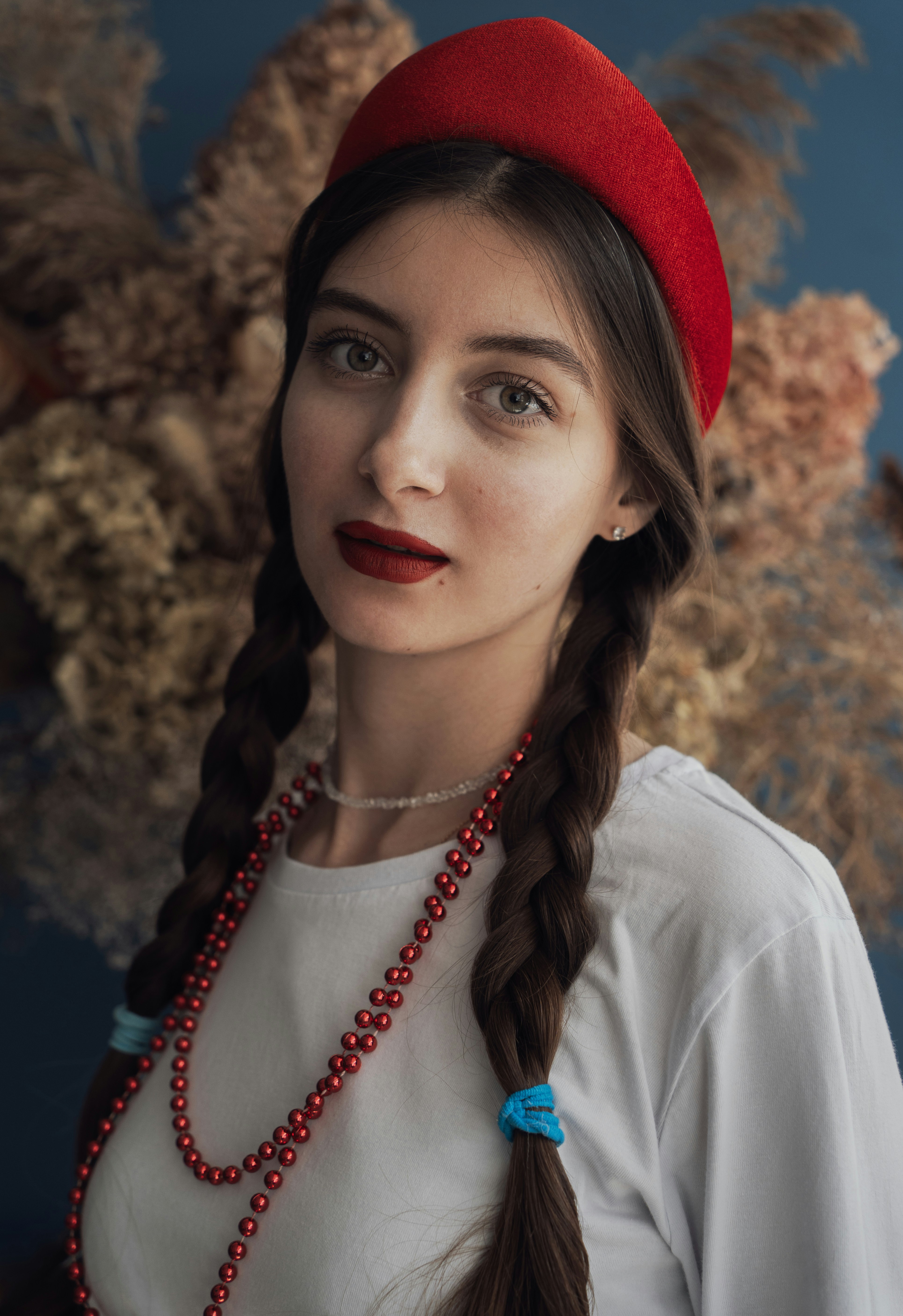 Red Beret Portrait: Braided Youth with Velvet Hue