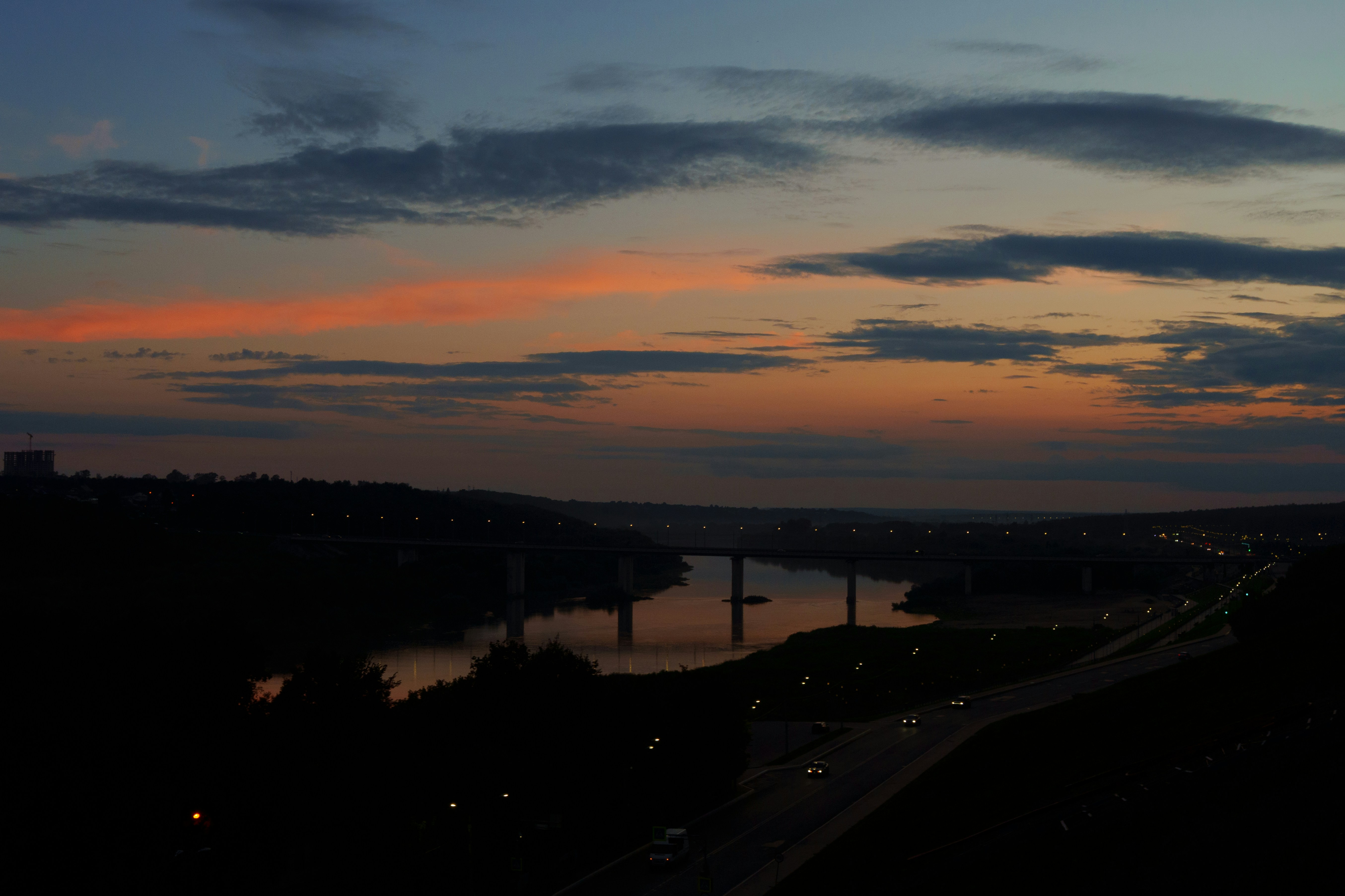Sunset Over the Quiet River: A Dusk Portrait of a Bridge Horizon