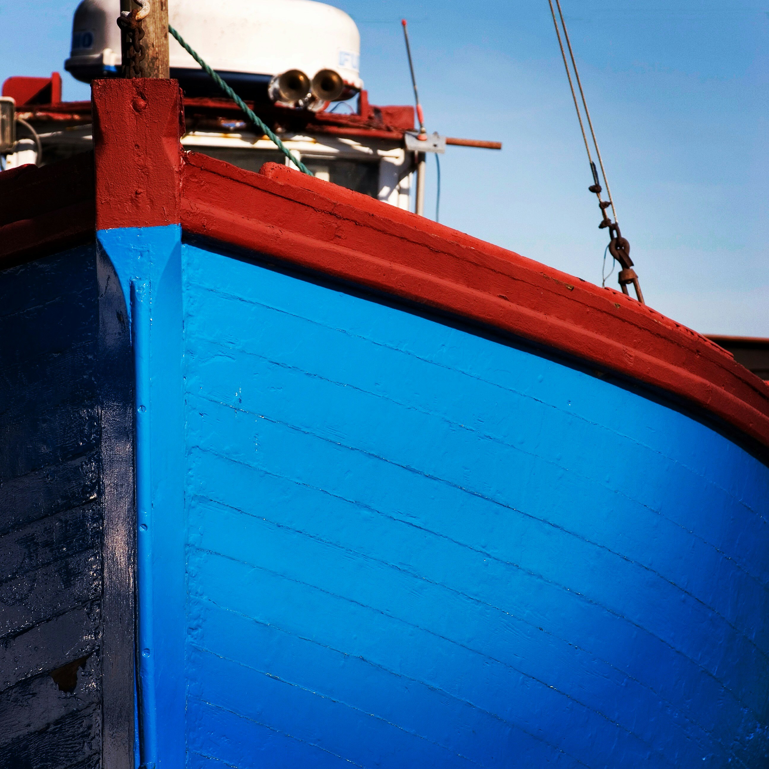 Bold Blue Hull and Crimson Trim: A Vessel at Rest