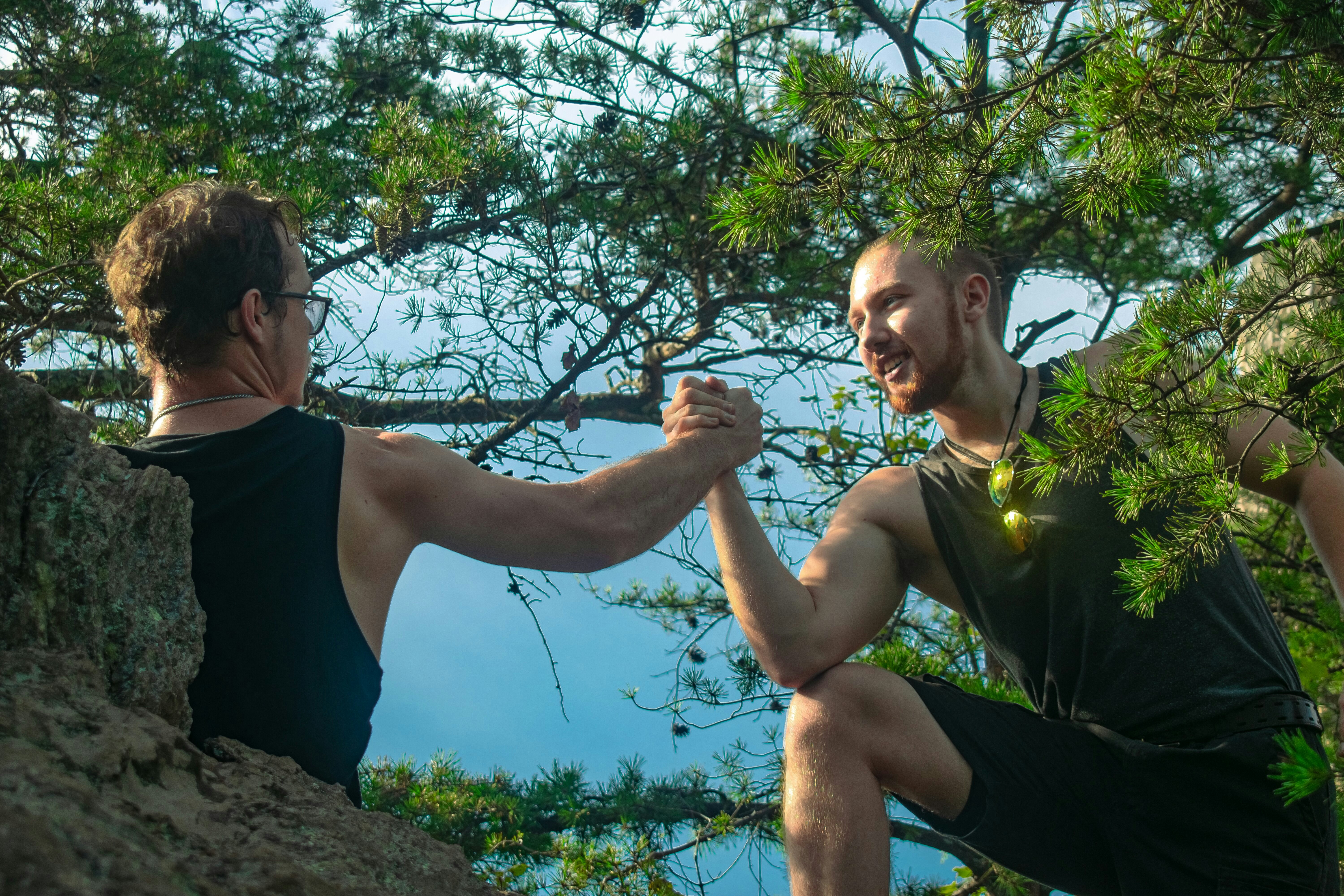 Handshake on the Edge: A Friendly Exchange Between Two Climbers