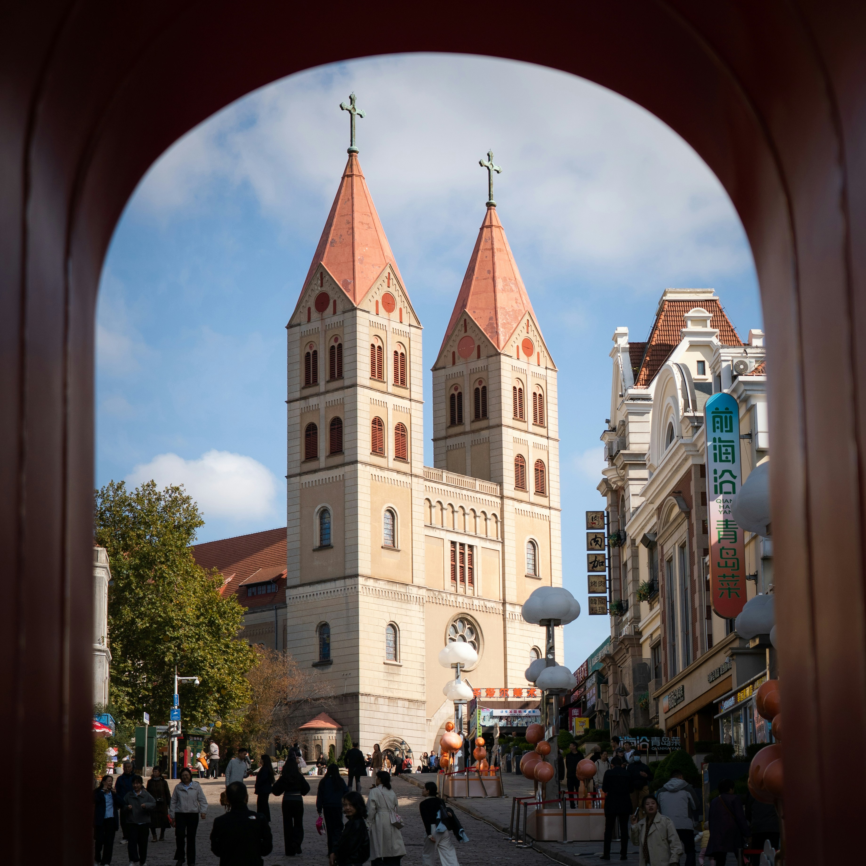 Twin-Tower Cathedral Framed by a Bustling Street Arc