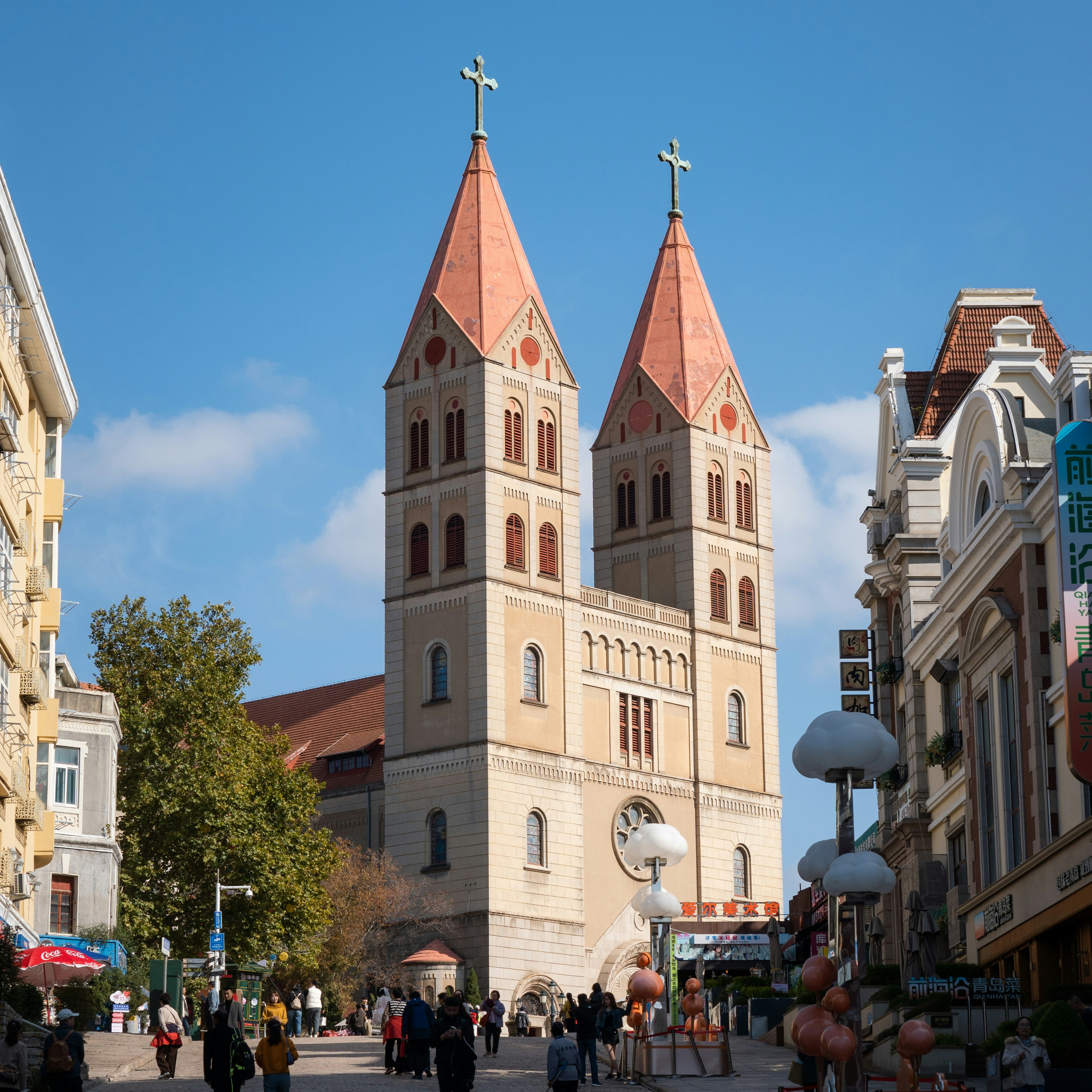 Twin-Spired Cathedral Looms Over Busy Street
