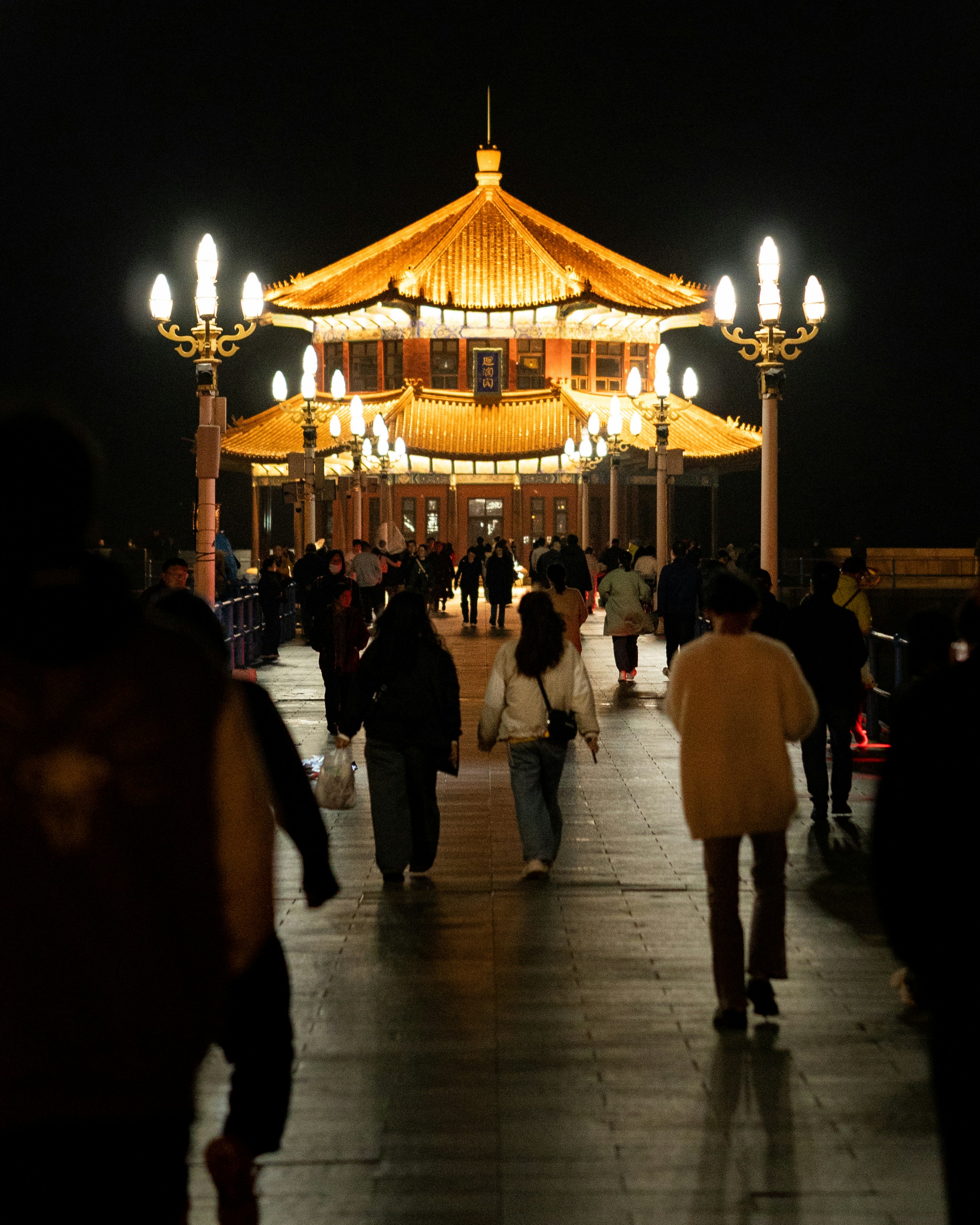 Golden Pavilion at Night: Lantern-lit Pathway to a Shrine-like Atrium