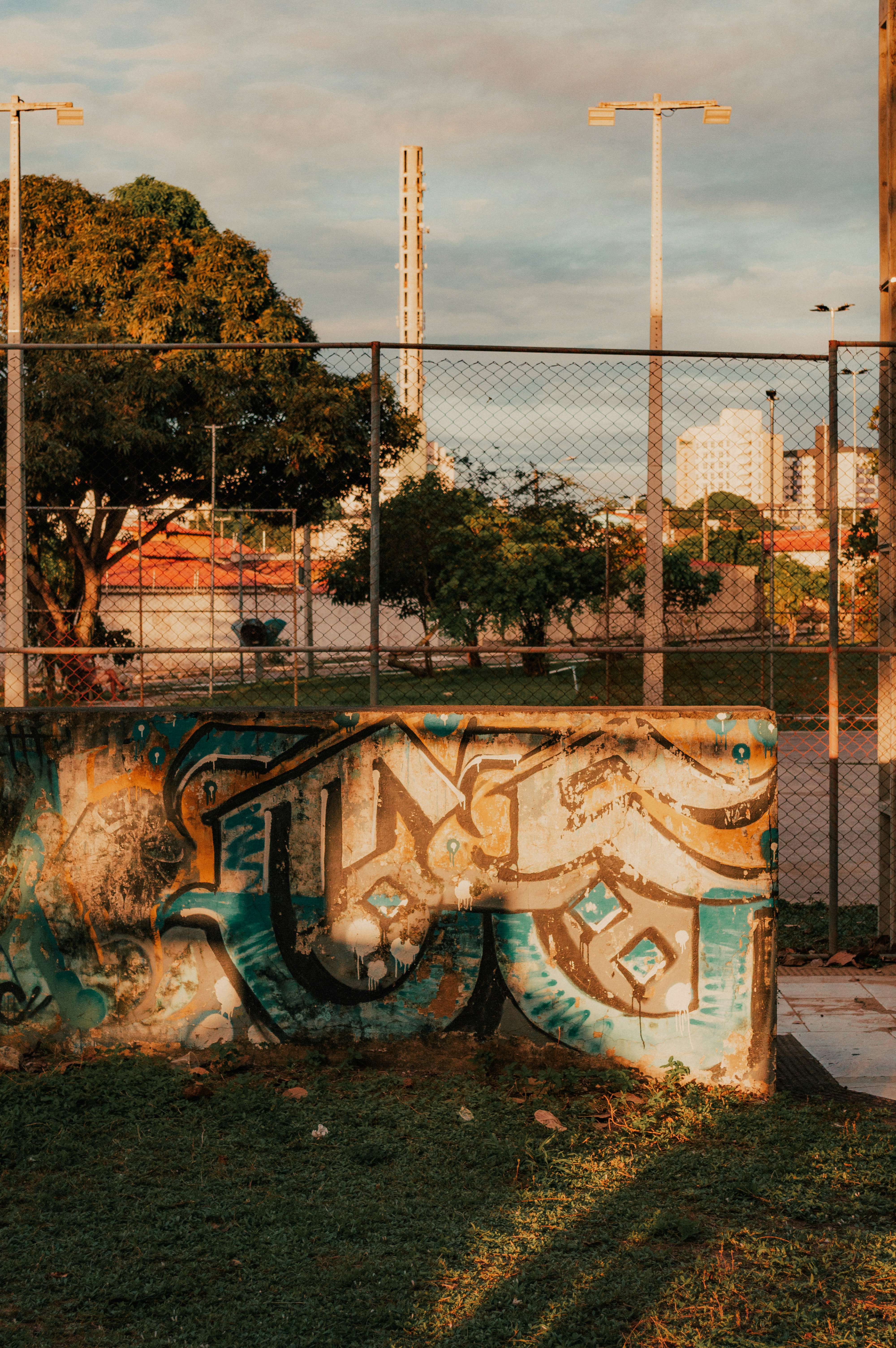 Graffiti Block Framed by Chain-Link and Sunset Light