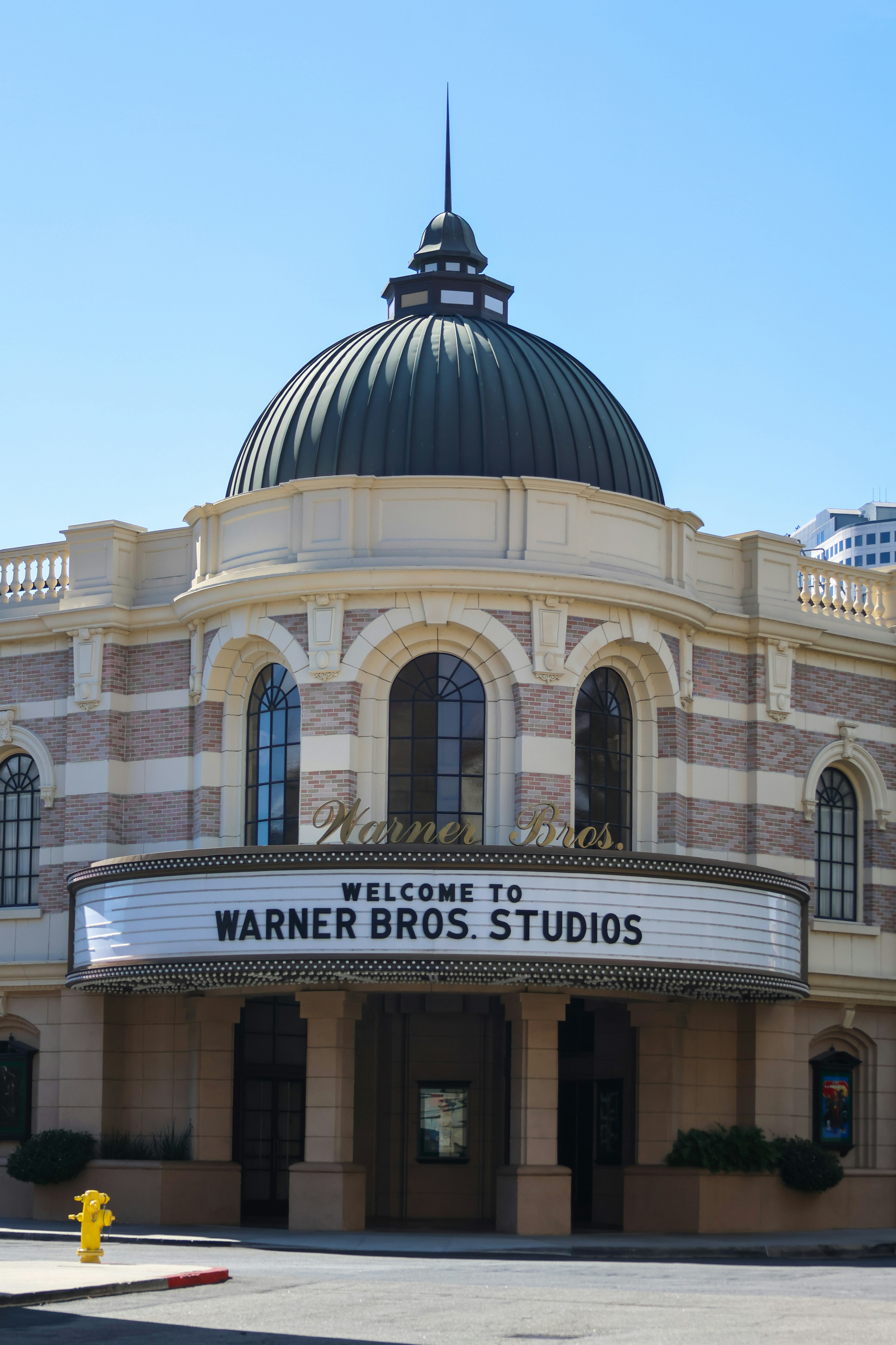 Warner Bros. Studios Facade: A Dome, Arches, and marquee under a clear sky