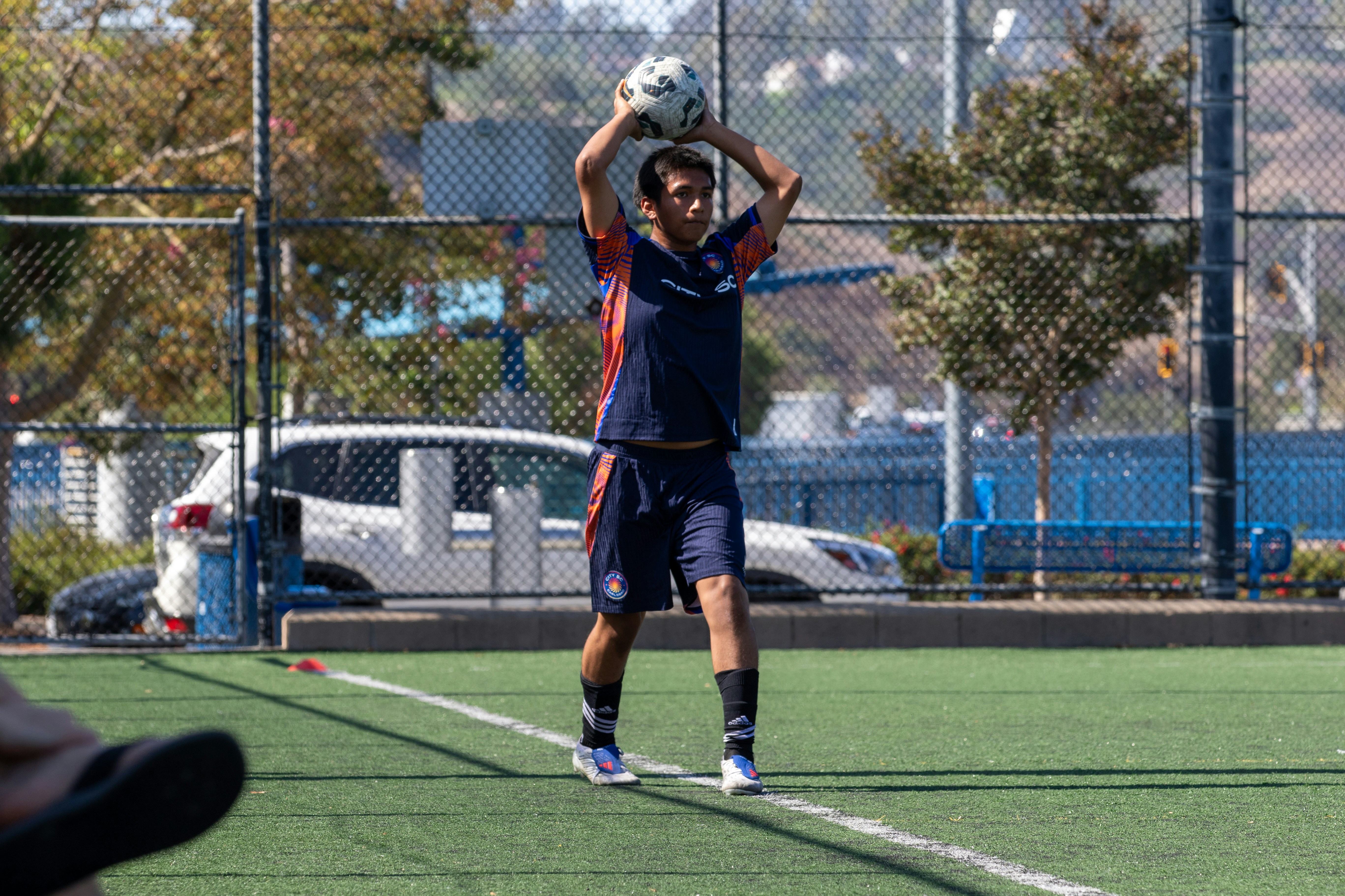 Keeper in Motion: Raising the Ball Under the Fence-line