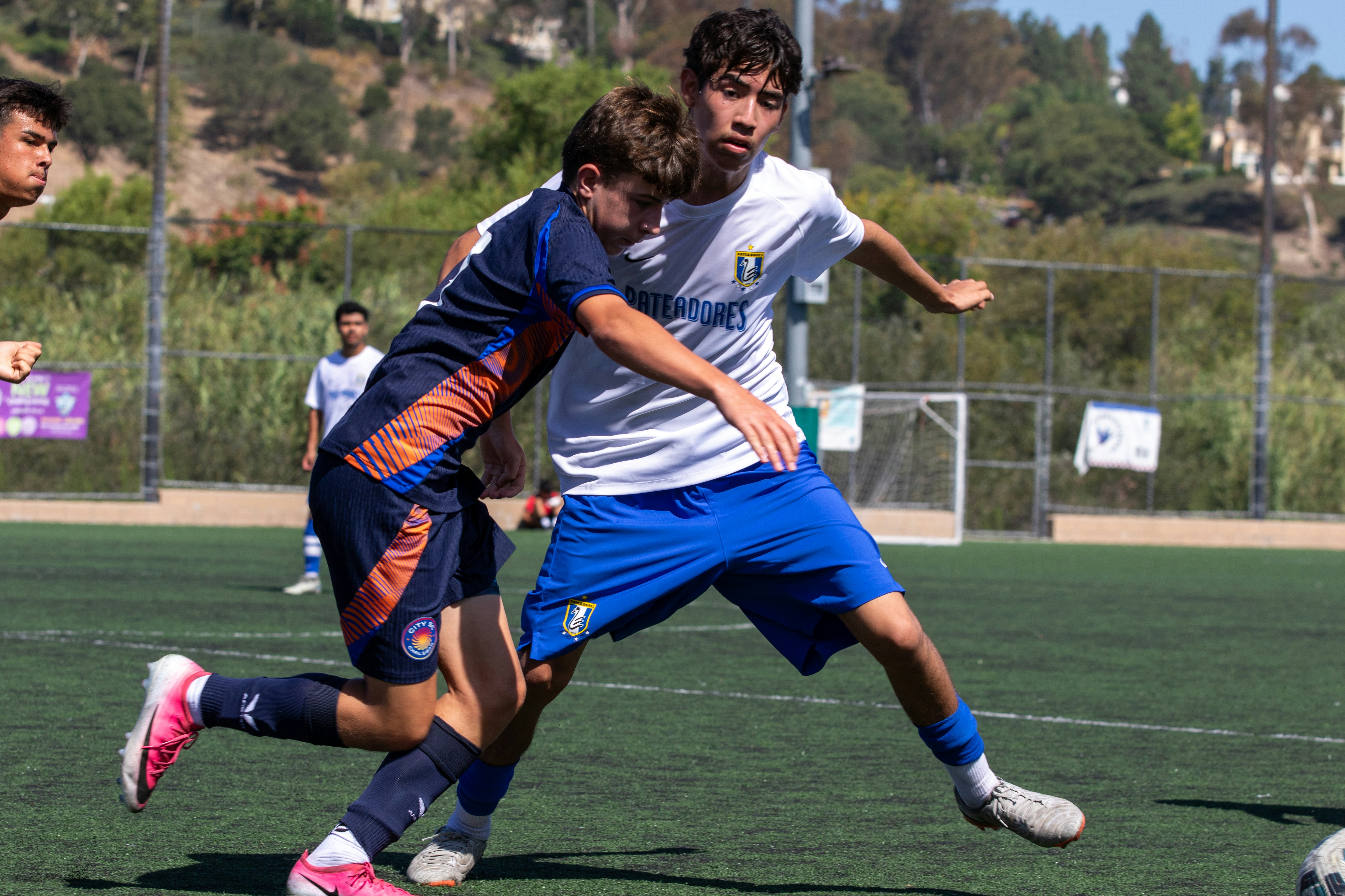 Collision in the Midfield: Two Players Locking Eyes on the Ball