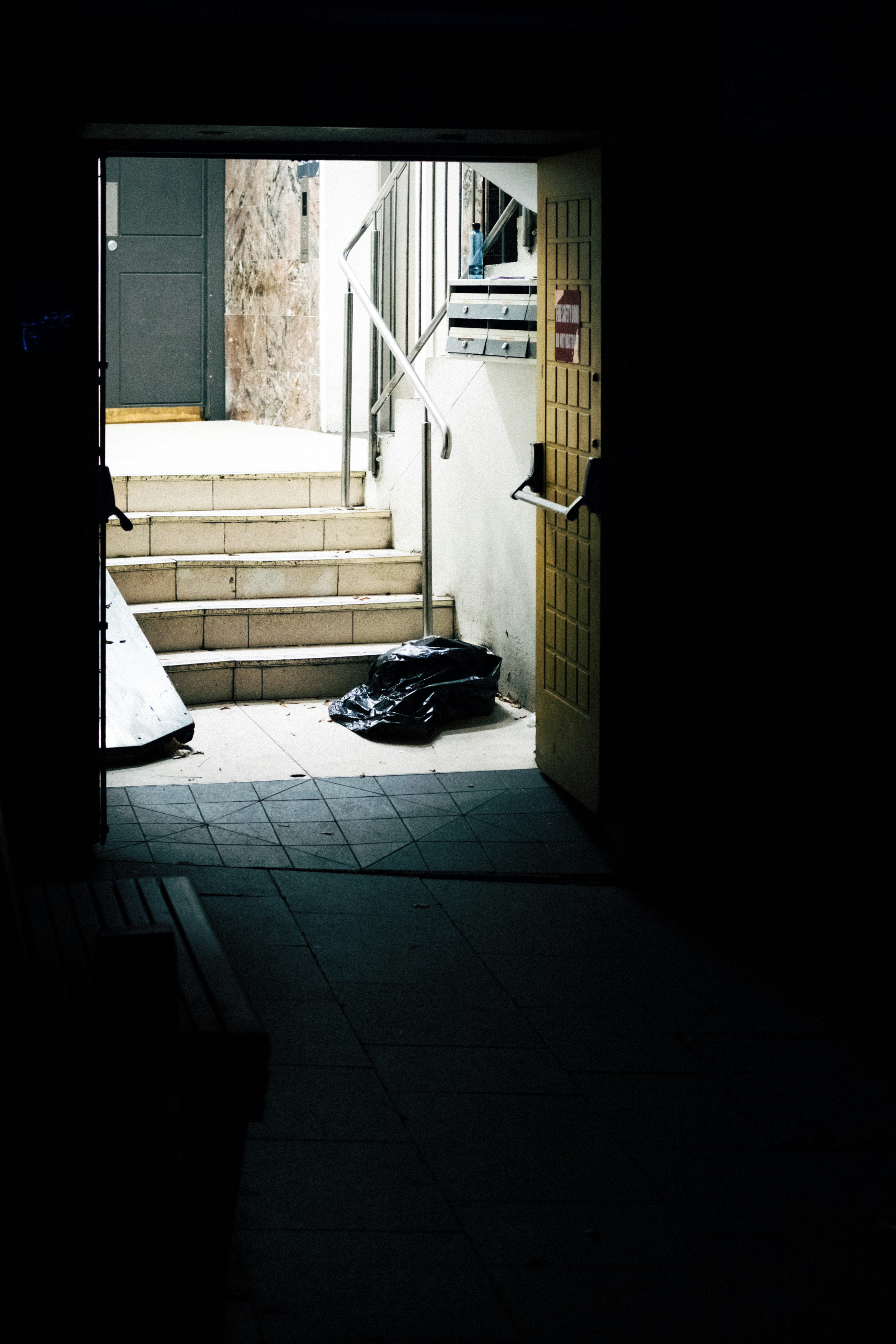 Light at the Staircase: An Exit Framed by Darkness