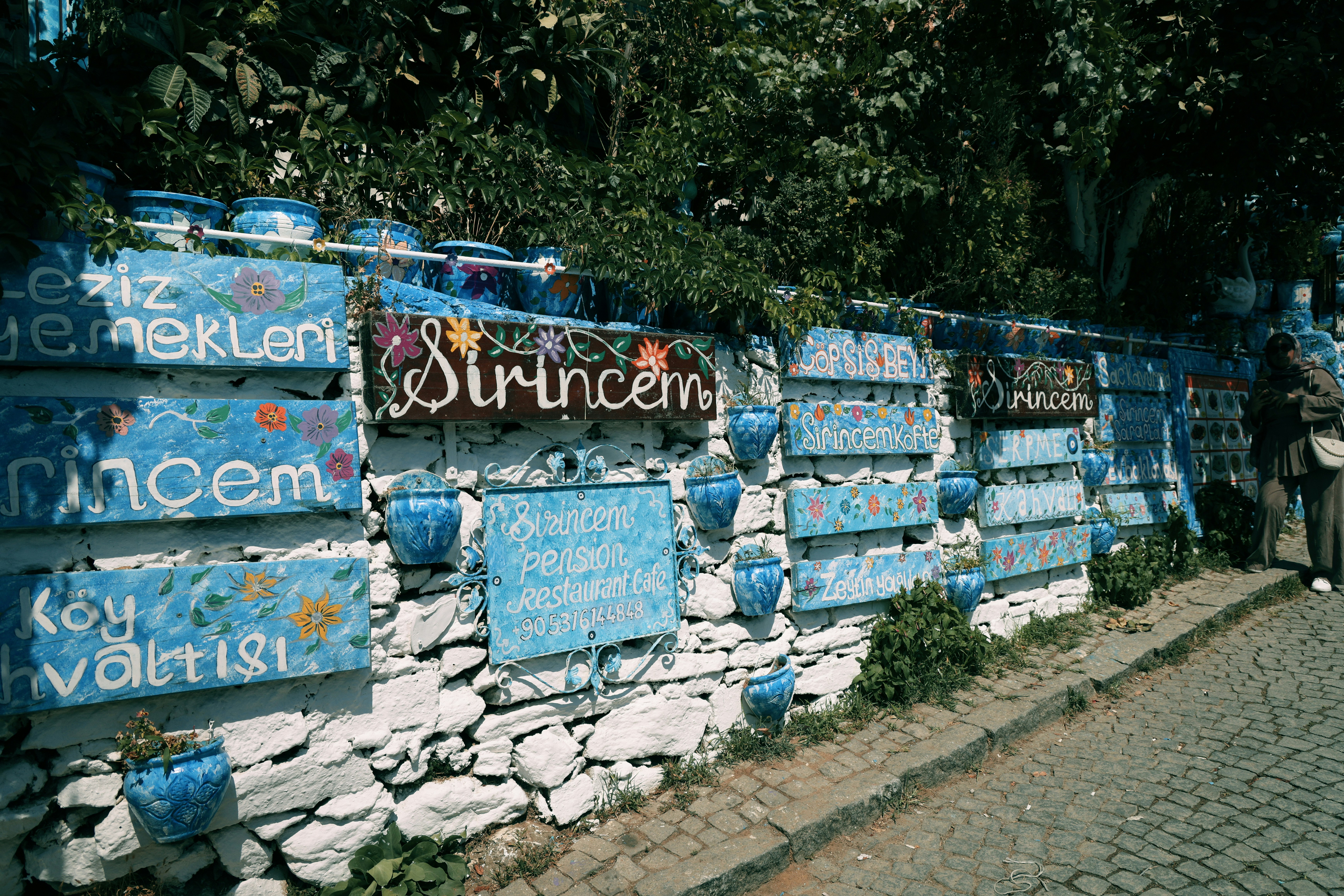 A Row of Cerulean Wall Ornaments and Chalked Messages