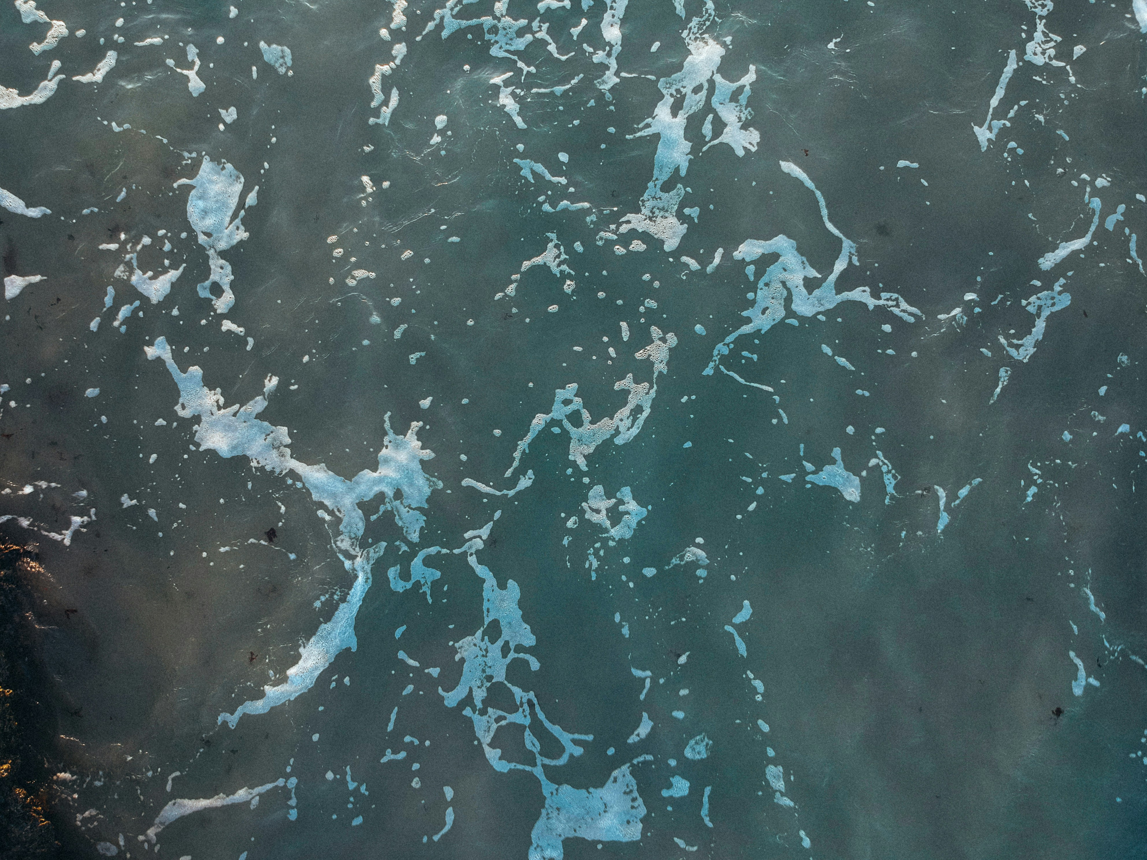 Aerial Drone View of Touros Beach, Rio Grande do Norte – Vila Galé ( 2025 ) A breathtaking aerial drone perspective of the pristine coastline at Touros Beach, Rio Grande do Norte, captured in 2025 near the Vila Galé resort. The sweeping composition showcases the vivid contrast between crystal-clear turquoise ocean waters, rolling white foam waves, and the golden sands of Brazil's northeastern shore. Palm trees and lush coastal vegetation frame the tropical landscape, while the endless horizon reflects the bright, sunny equatorial sky. This high-angle viewpoint captures the untouched natural
