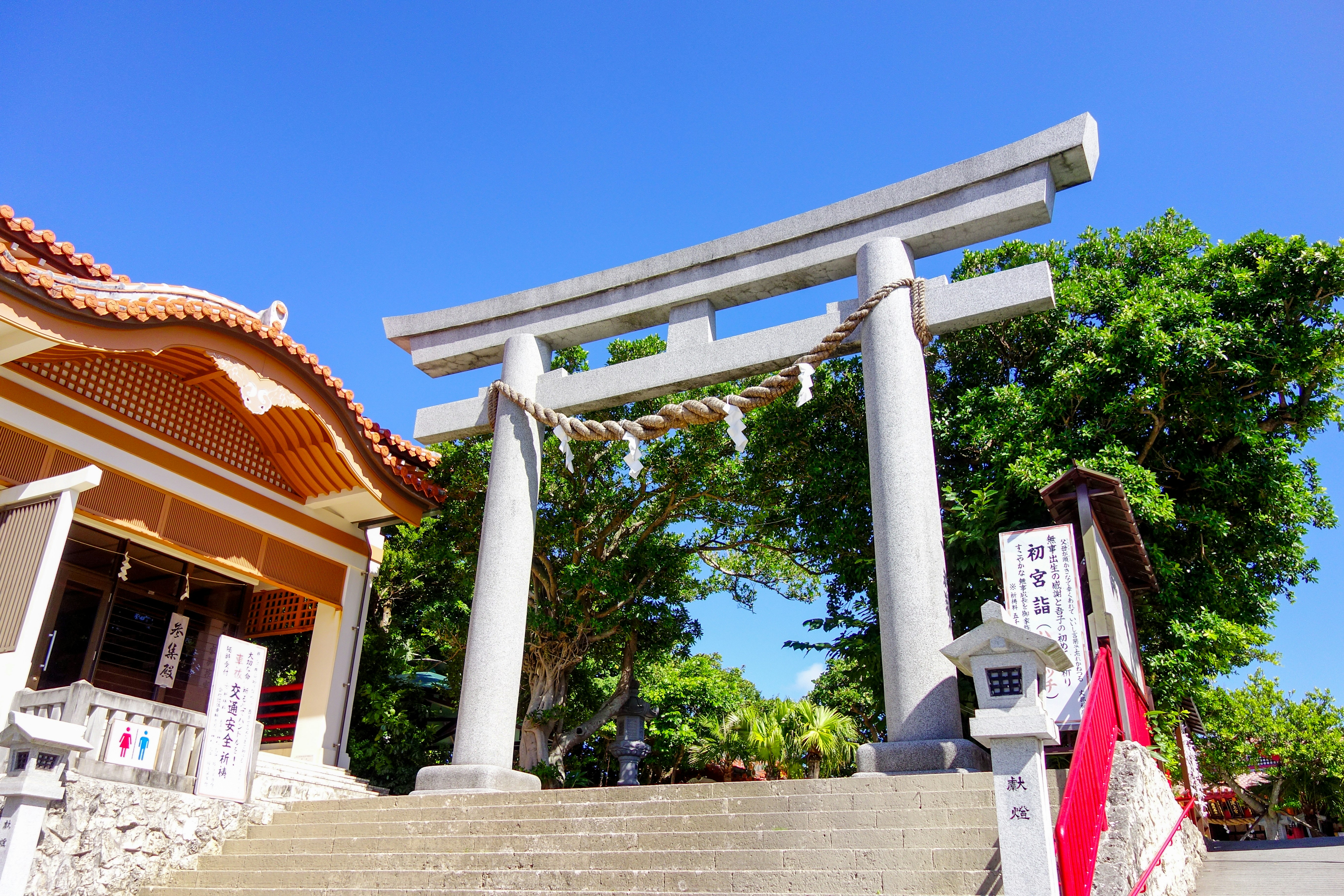 Gateway to Tranquil Heights: A Torii Silhouette Against a Sunlit Shrine