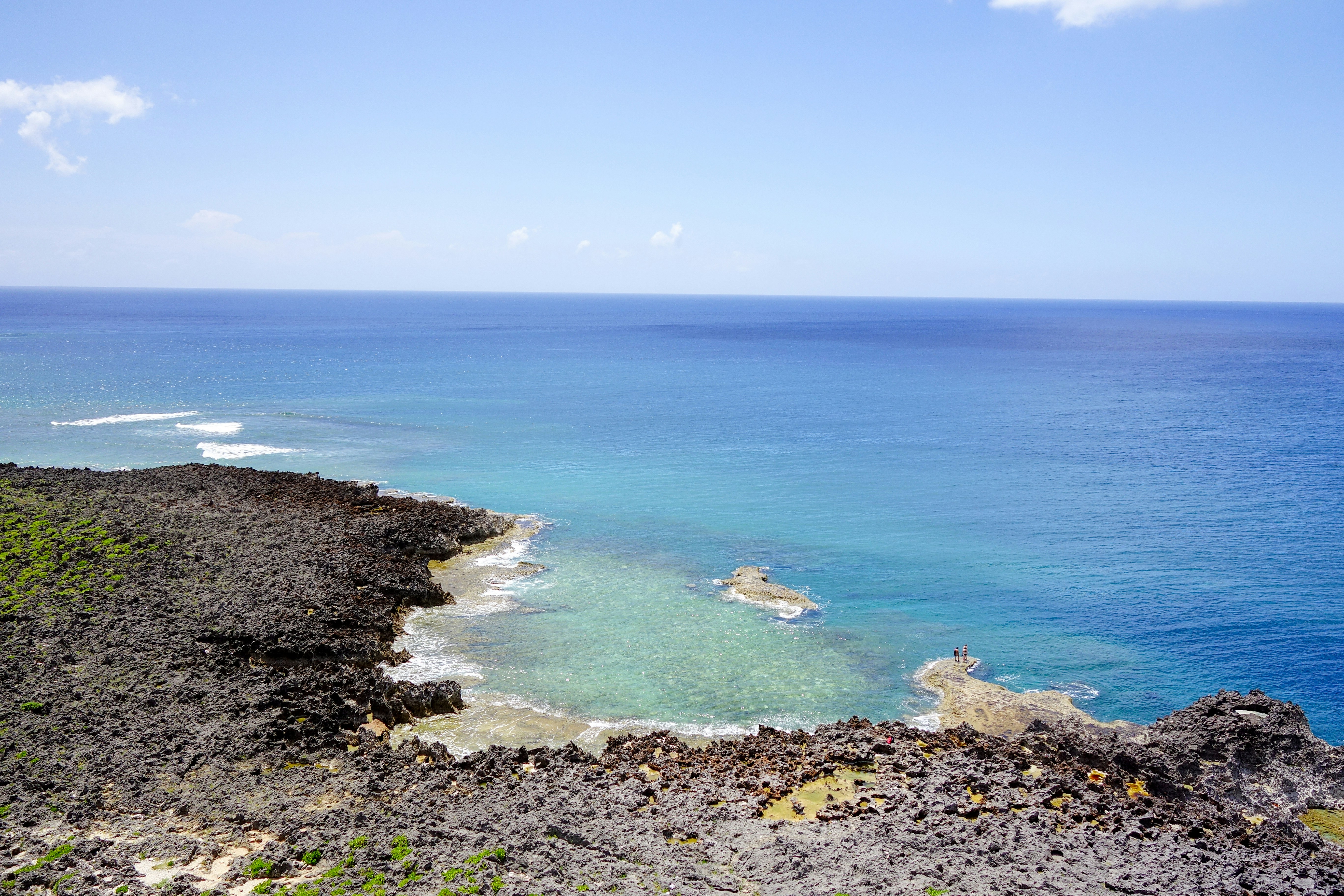 Edge of Blue: Quiet Coastal Cliffs Meet Clear Reef