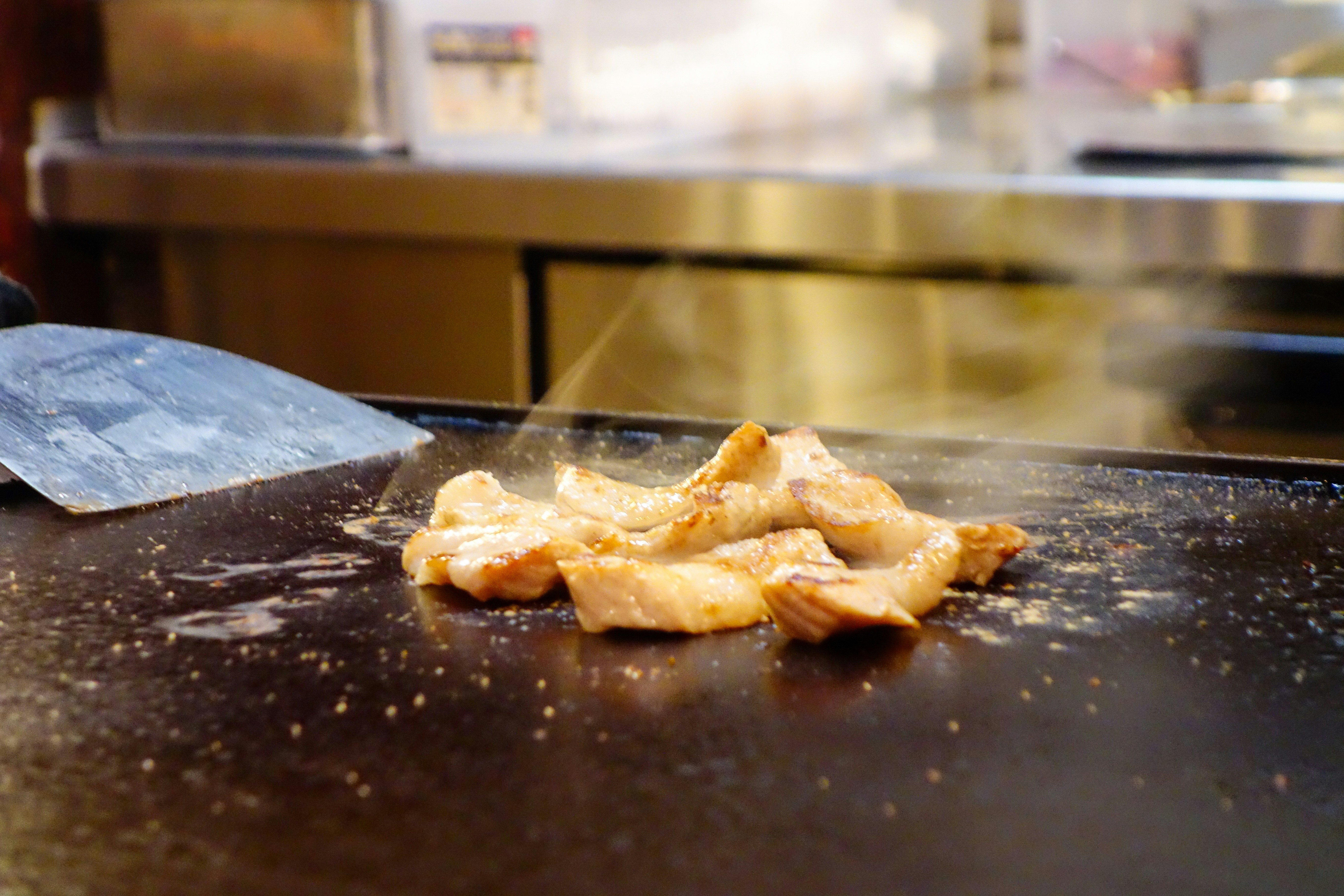 Sizzling Shards: Chicken Grill on a Busy Kitchen Griddle