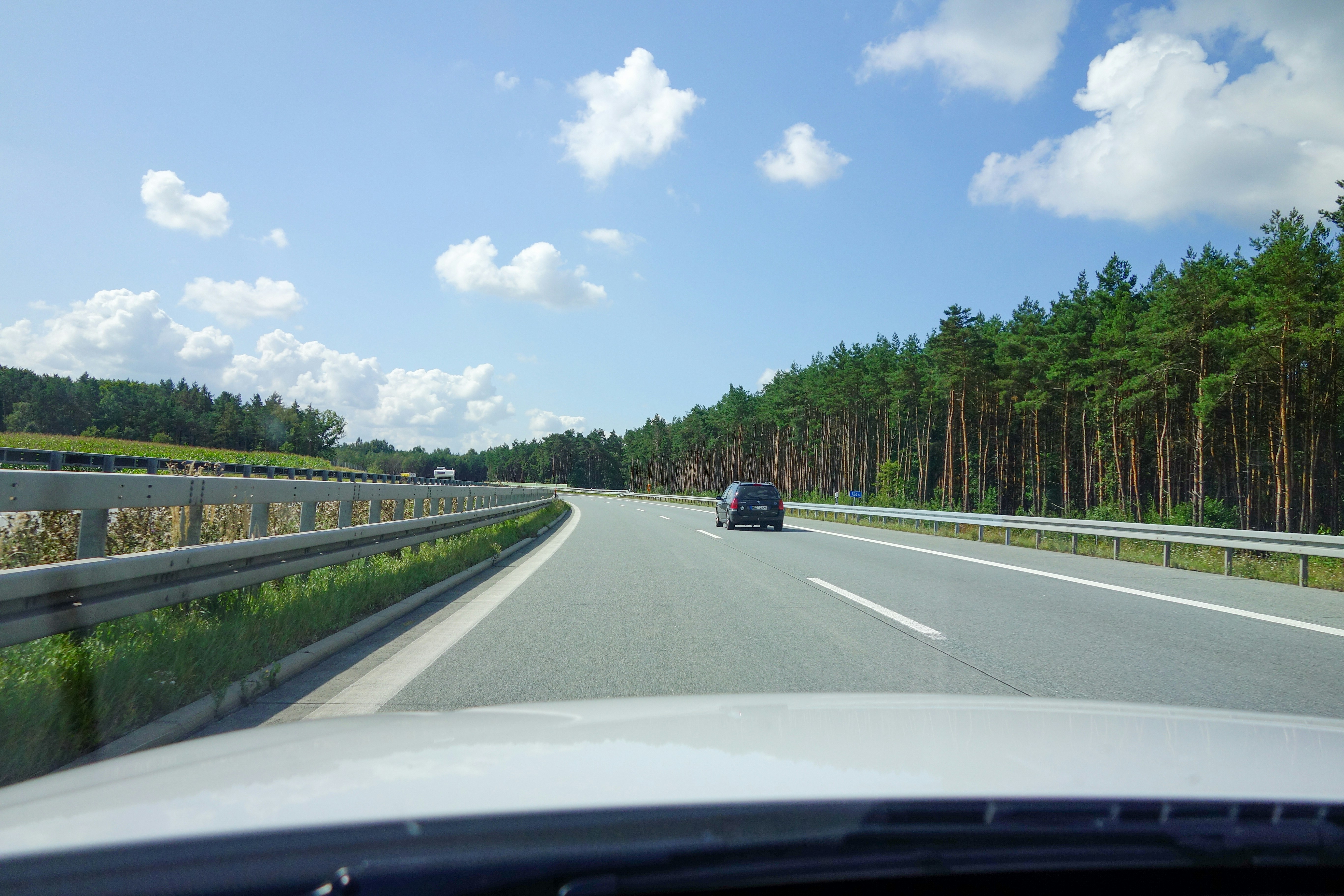 Road Ahead: Car in the Center of a Sunny Highway Slice