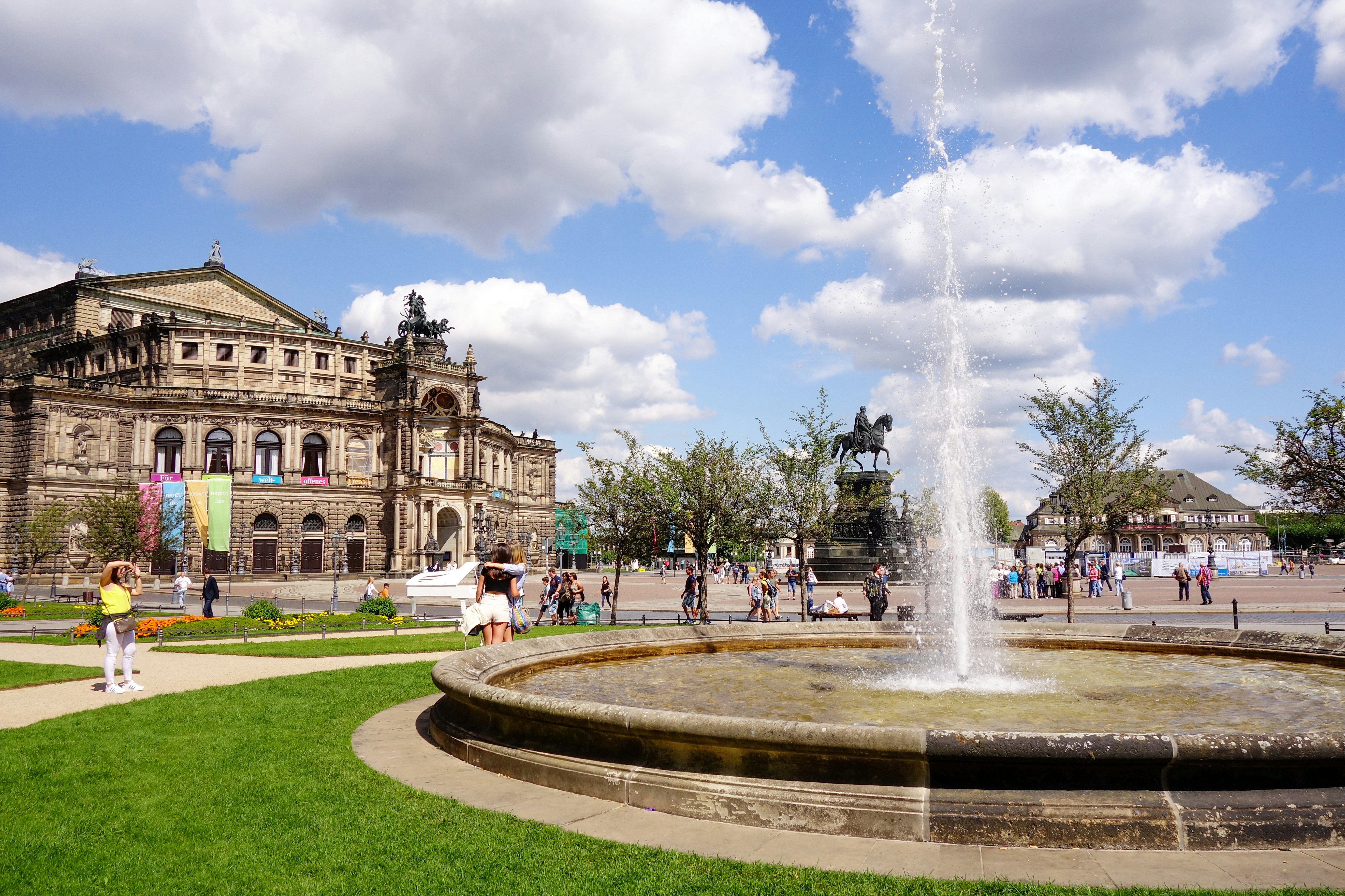 Statue, Fountain, and Grand Theater: A Sunlit City Square