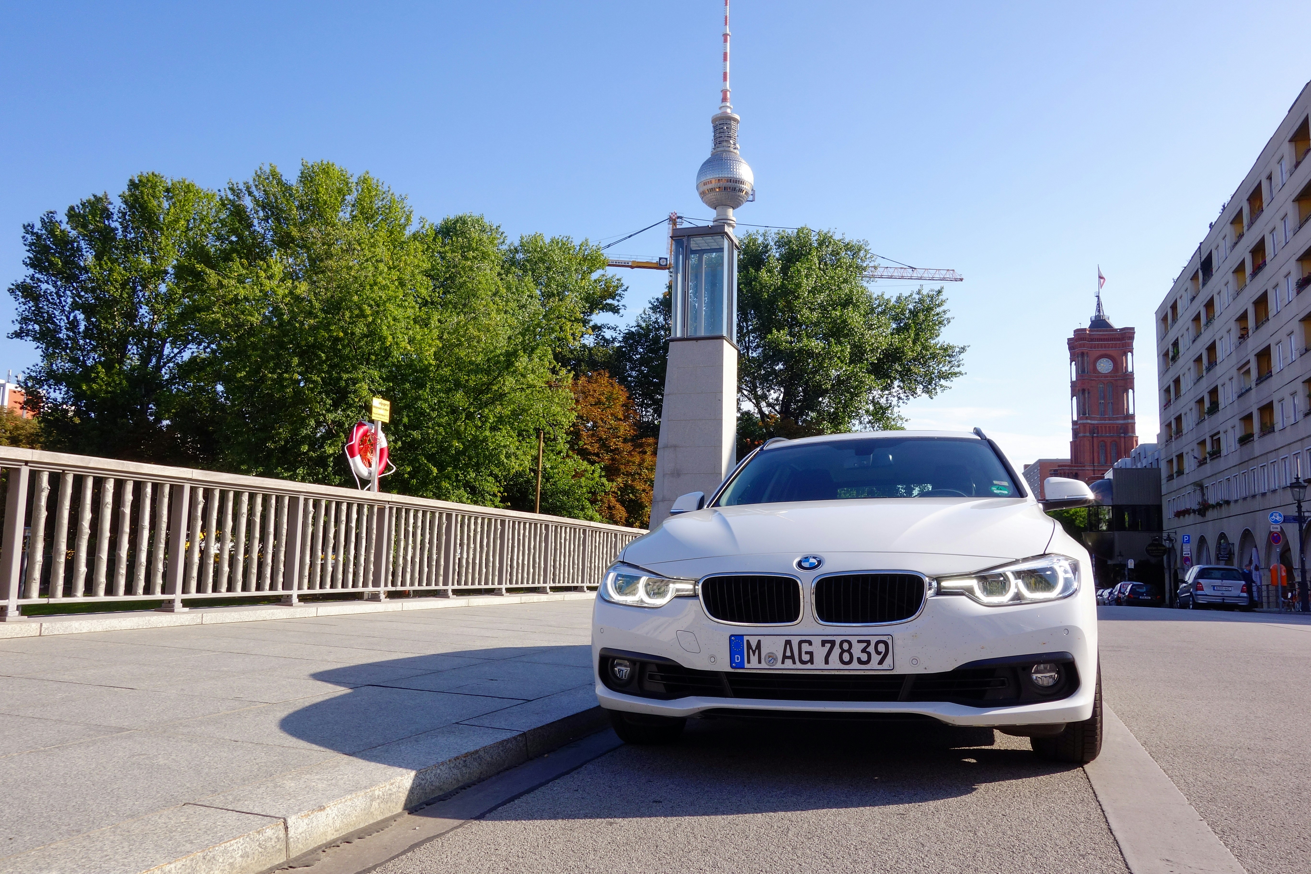 City Car at the Spire: A White BMW Boldly Anchors Berlin’s Riverwalk