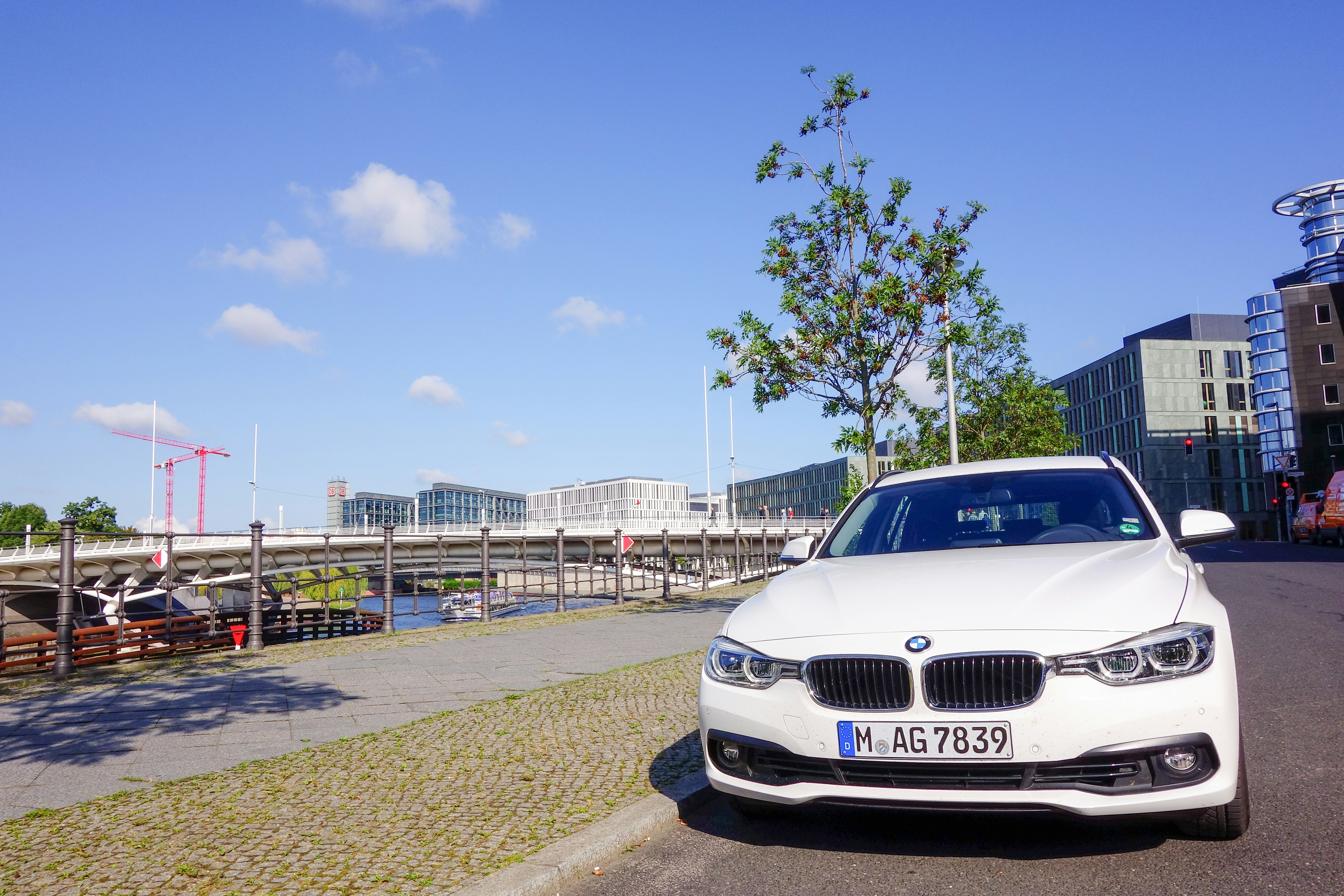 White BMW by the Waterfront: Chrome Reflections and Urban Sky