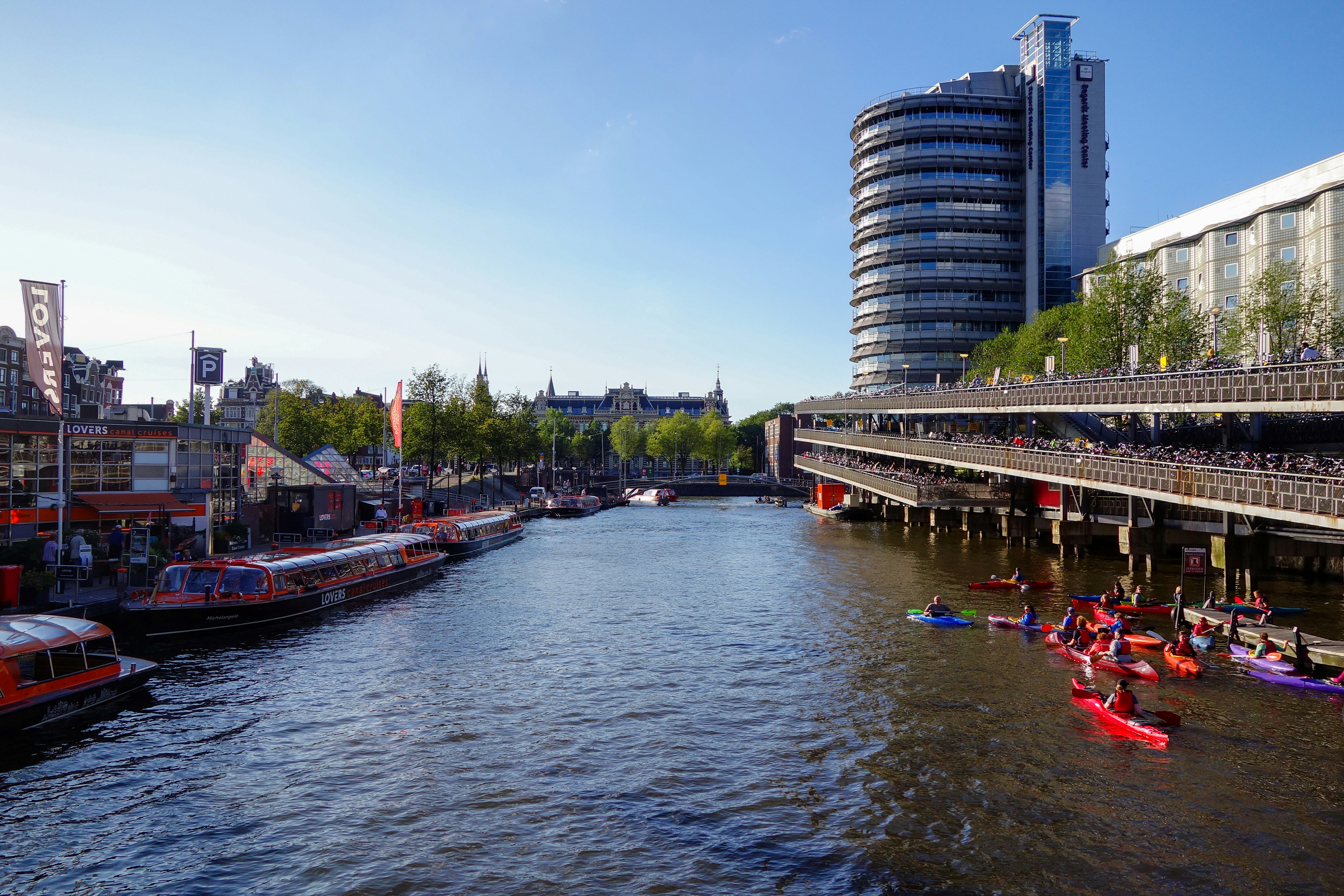 Urban Thames: Boats, Bridge, and Modern Tower Along the Riverwalk